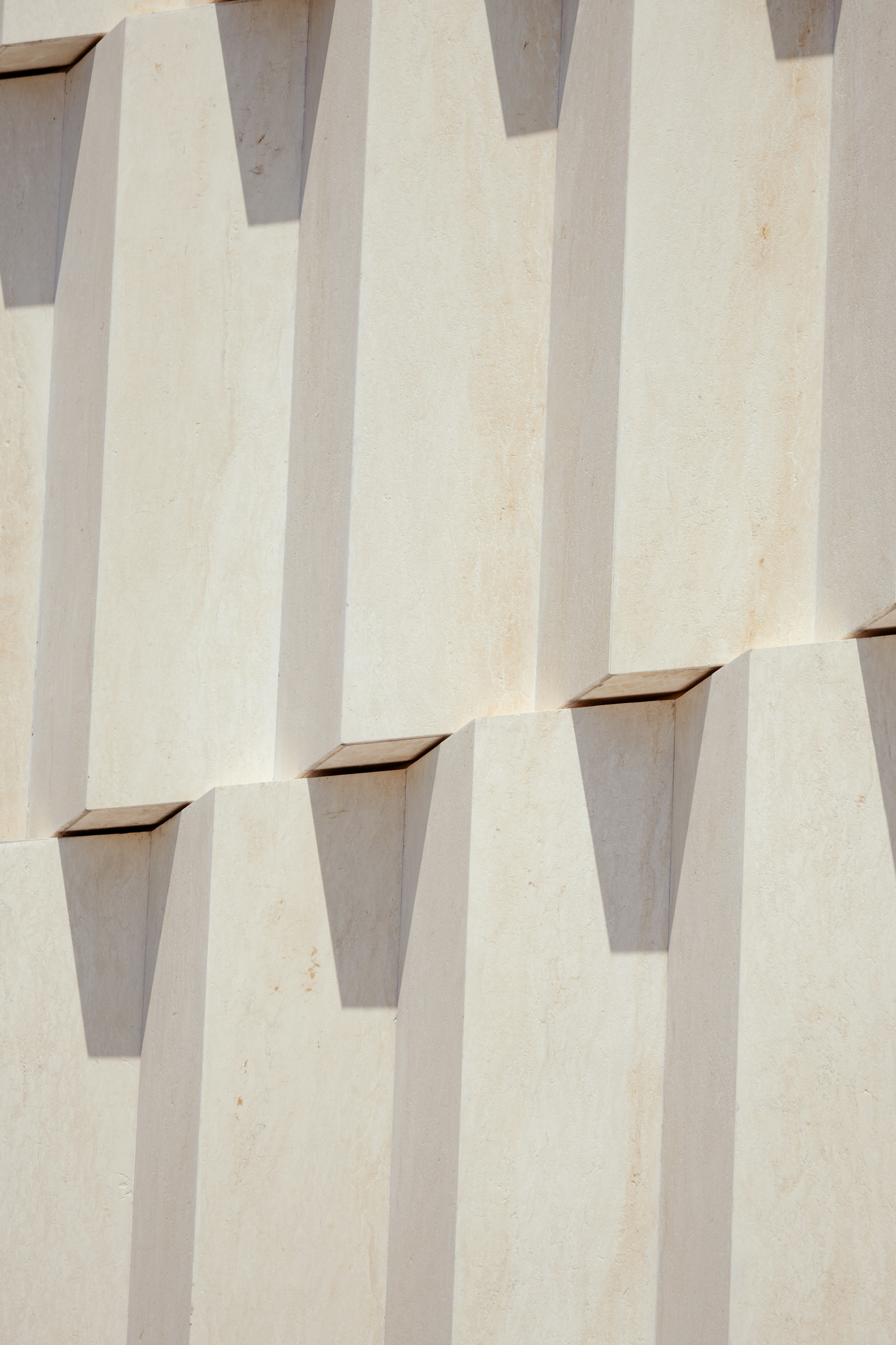 Rising Angles: A Skin of Shadows on a Facade