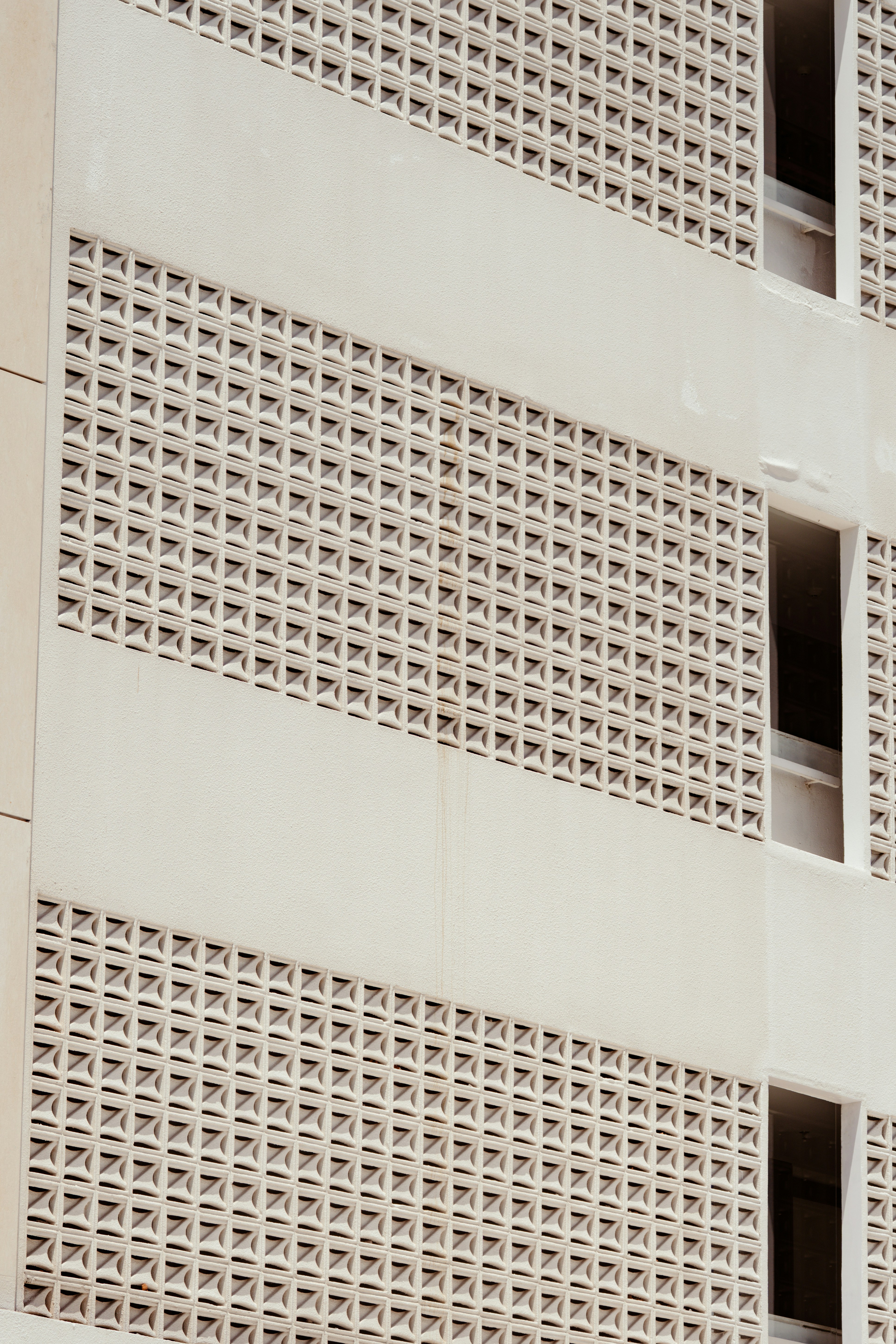 Patterned Light: A Concrete Lattice against Sunlit Facade