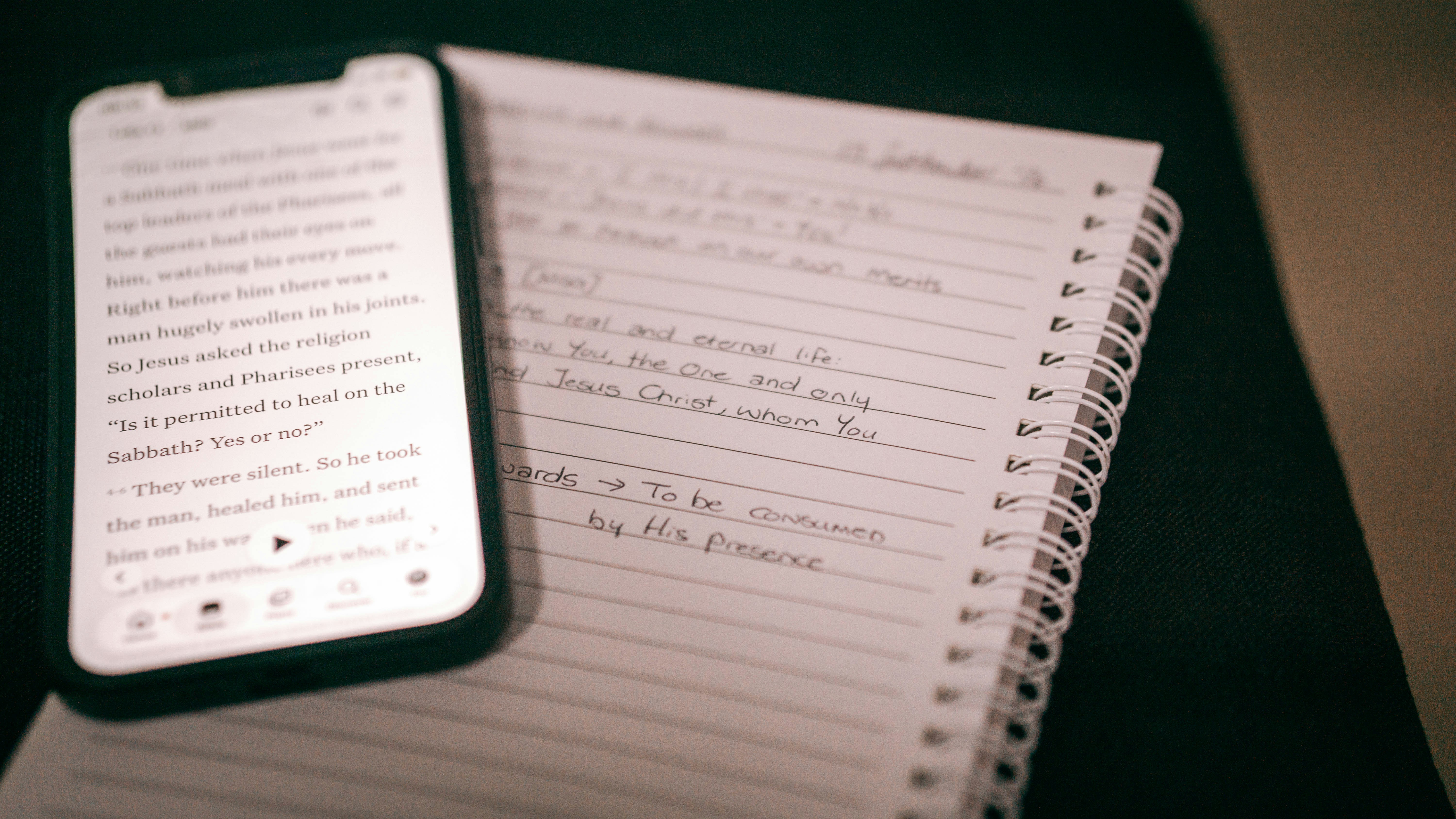 Notes and Screen: A Quiet Moment with a Ringed Notebook and a Phone