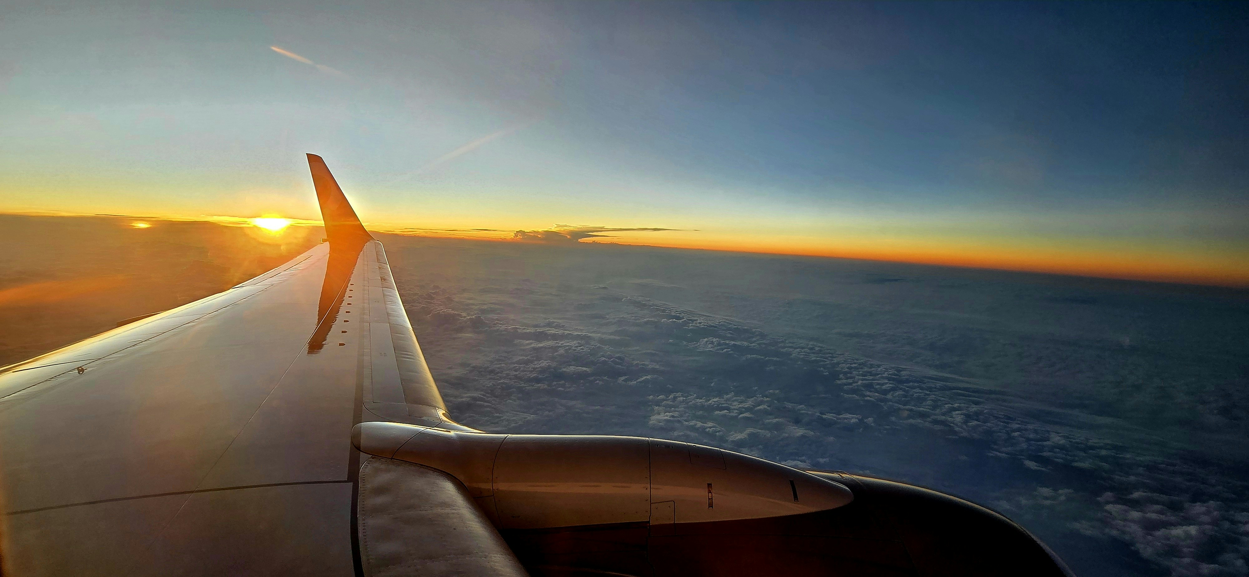 Golden Hour Wing: Sunrise Over the Clouds