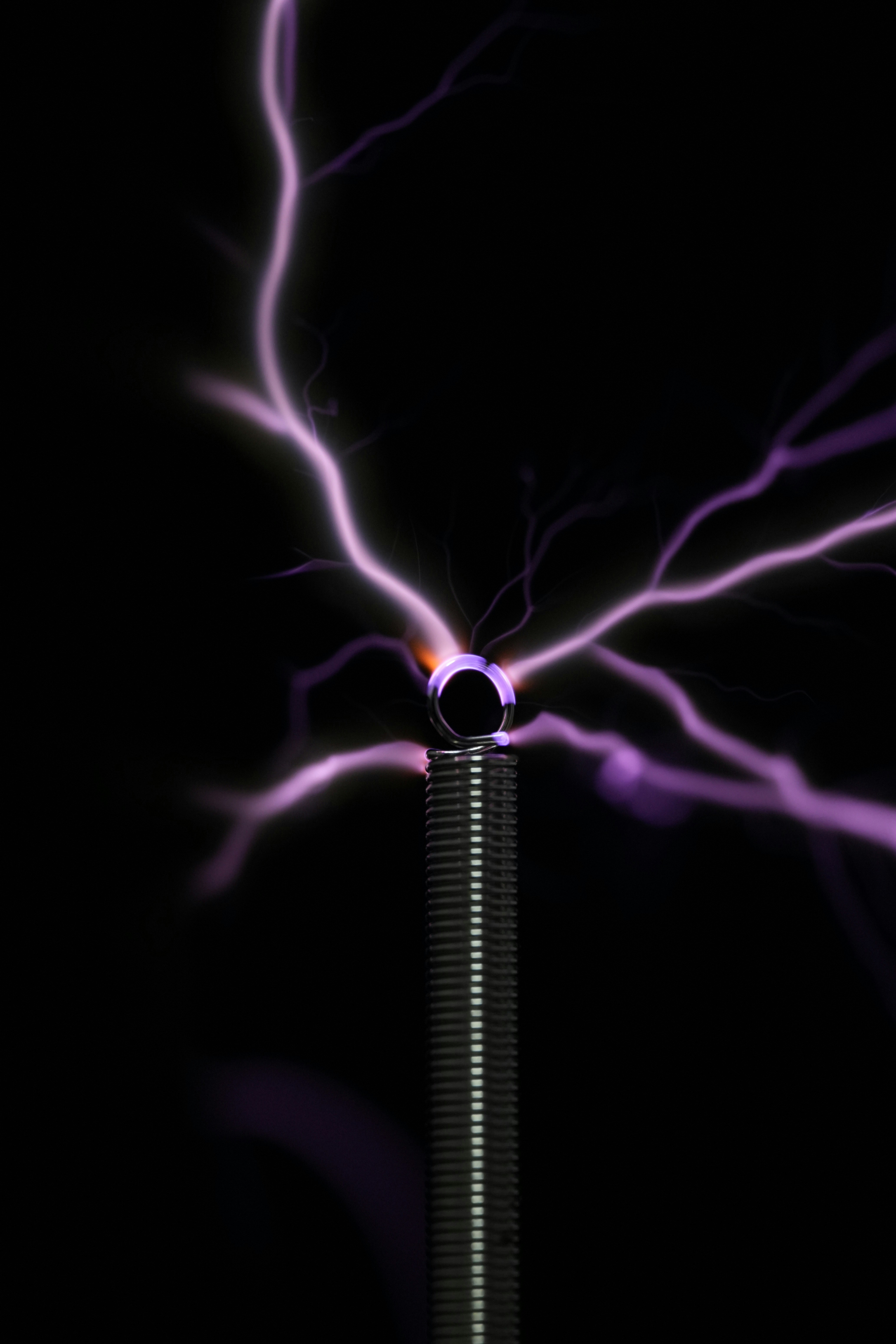 Electric Ring: a bent ring powers a neon arc from a coiled electrode