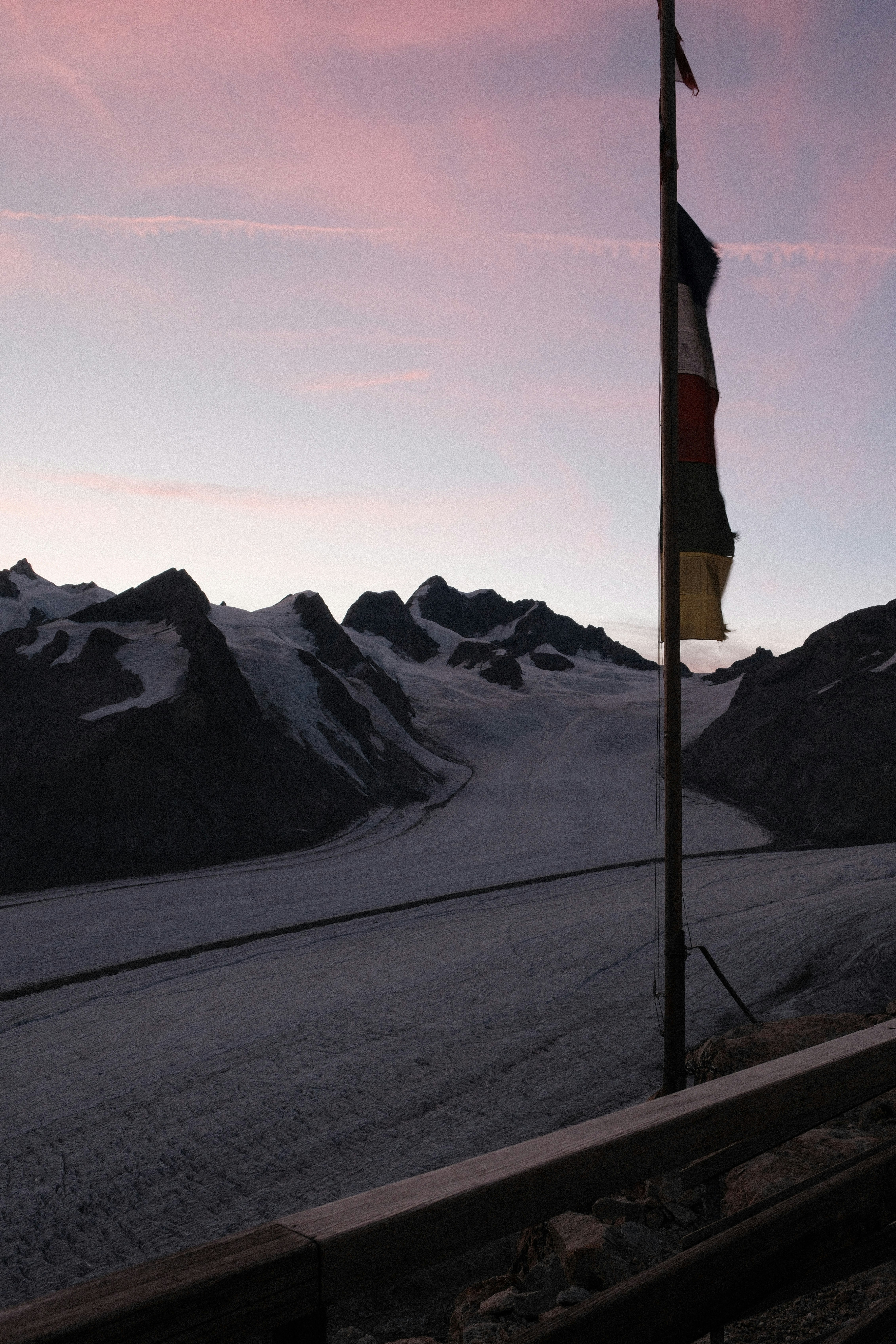 Timber Pole at Alpine Sunset Over Glacier Rim