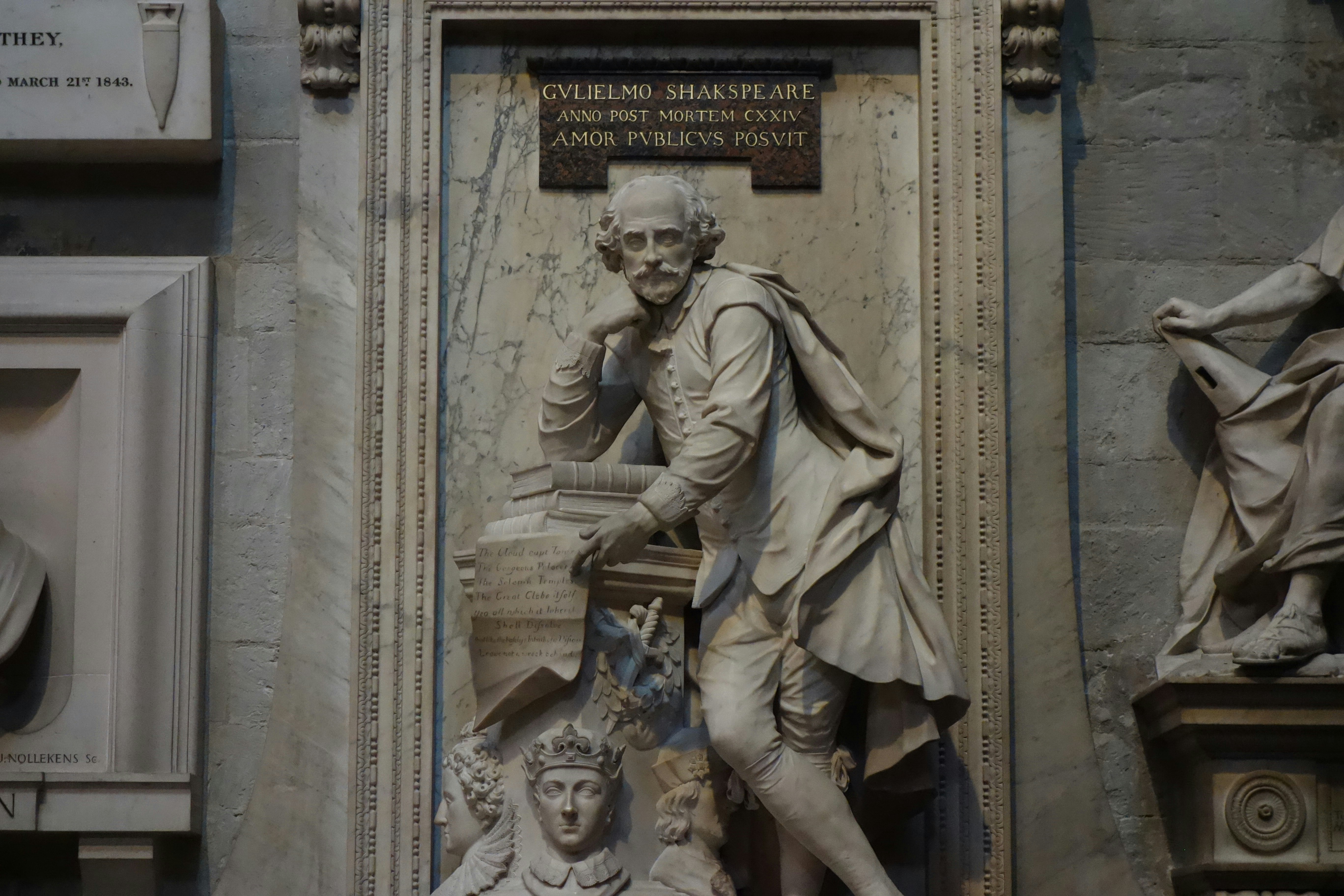 Sculpted Scholar: A Classical Bust Beneath a Weathered Plaque