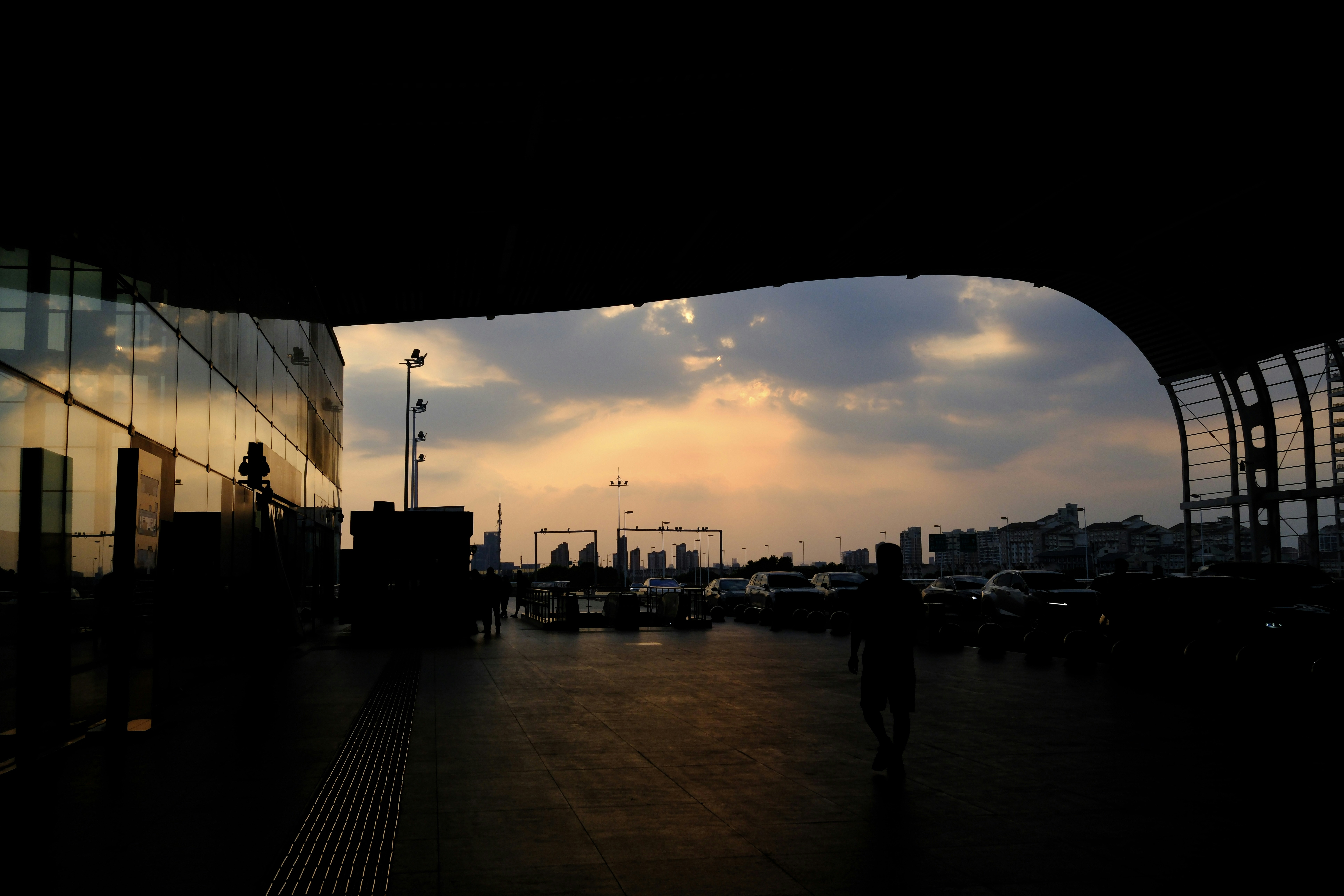City Arrival at Dusk: silhouette in the arched gallery