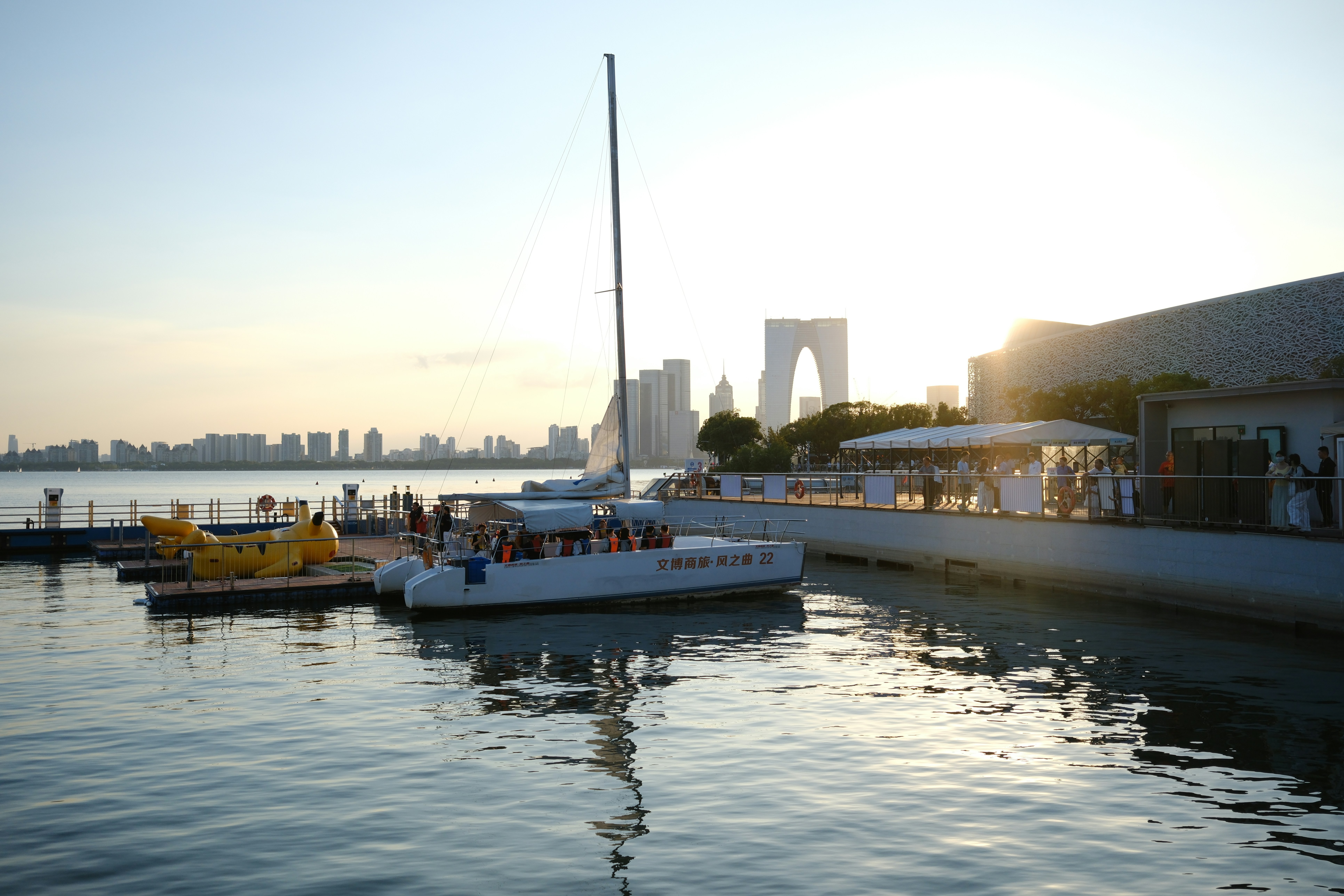 Sunlit Marina: A Silhouette of Boats and a City Skyline