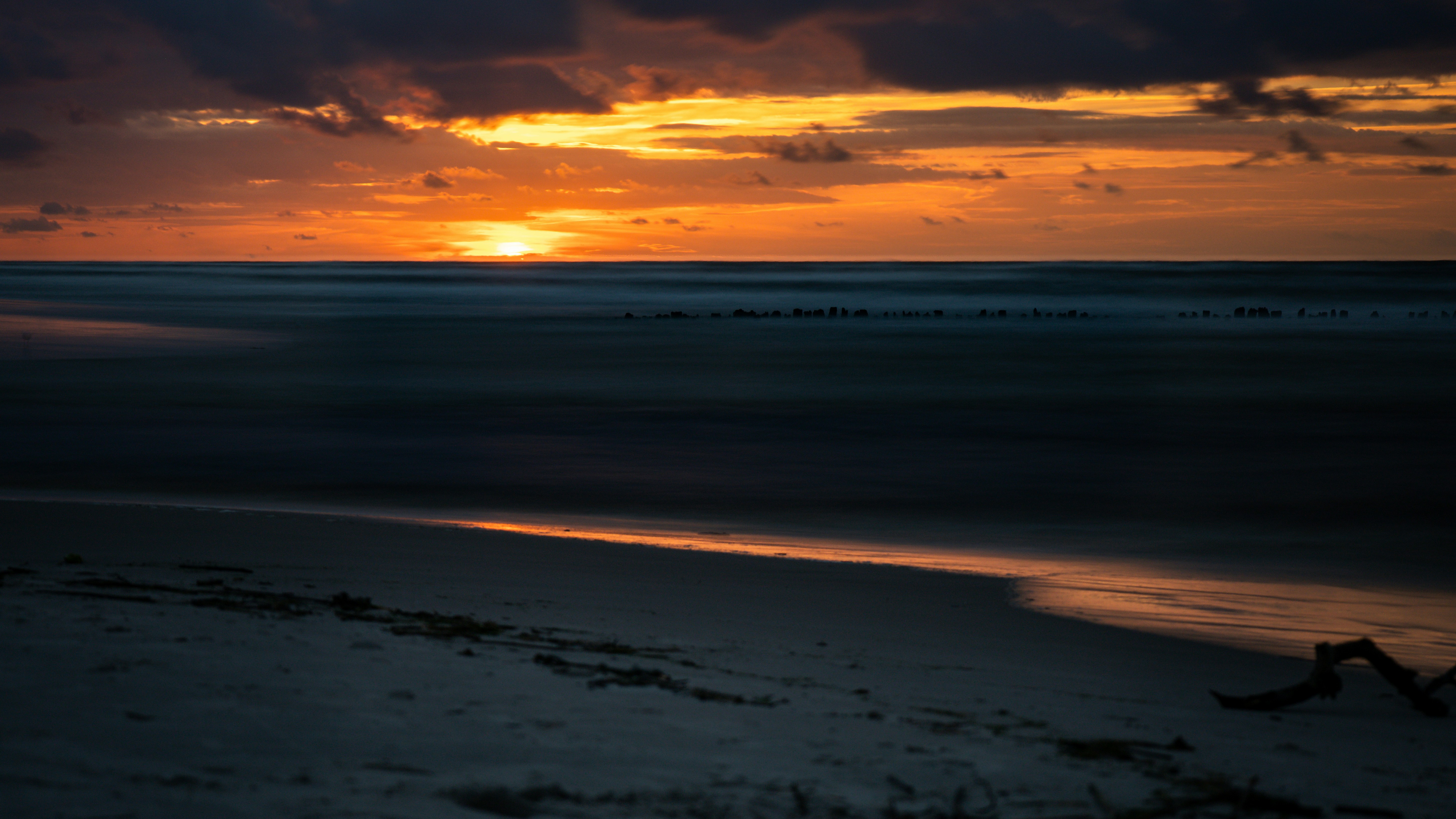 Horizon Fire: Dusk Over a Quiet Seashore