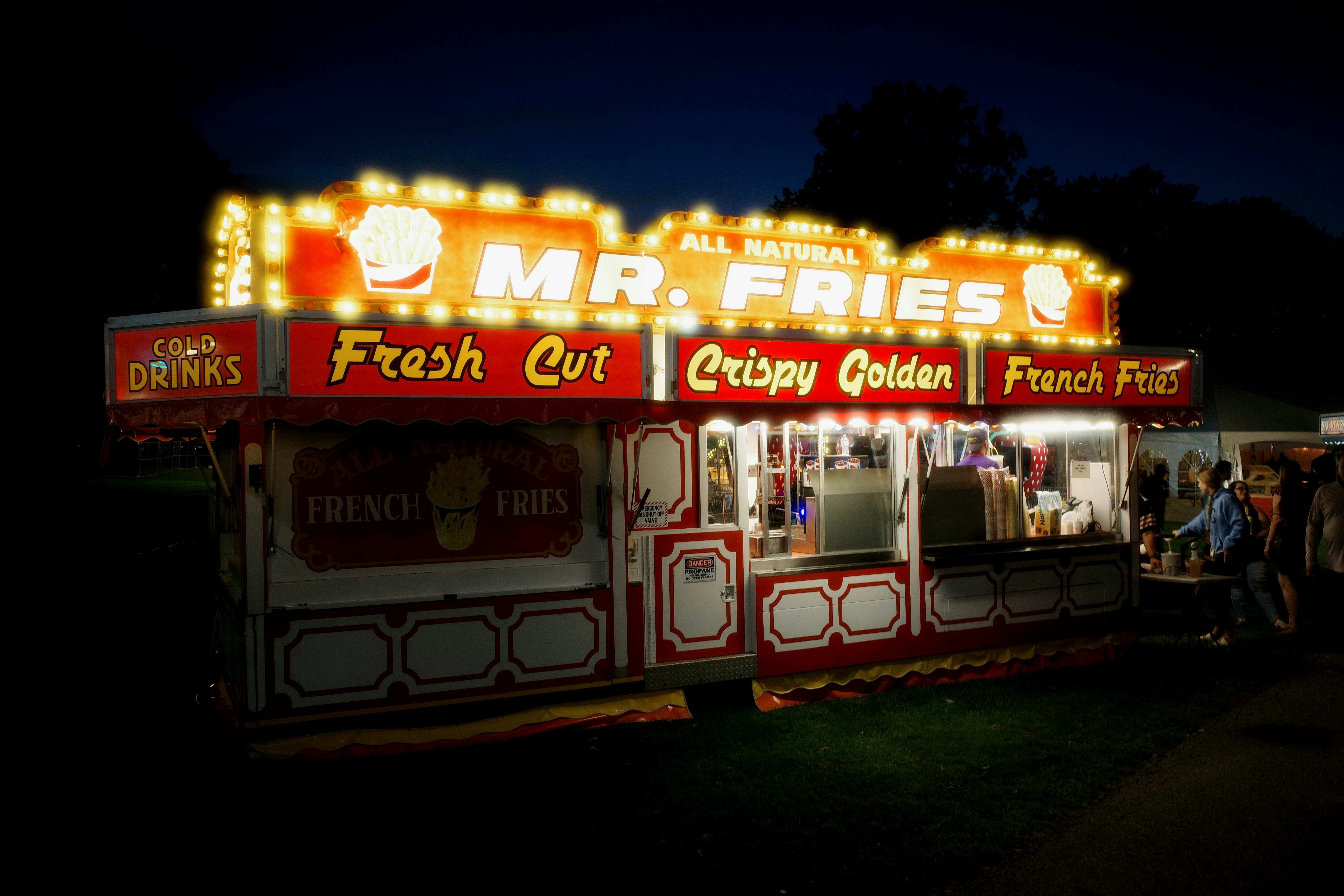 Mr. Fries Carousel: Crispy Golden Night Lights at the Food Stand
