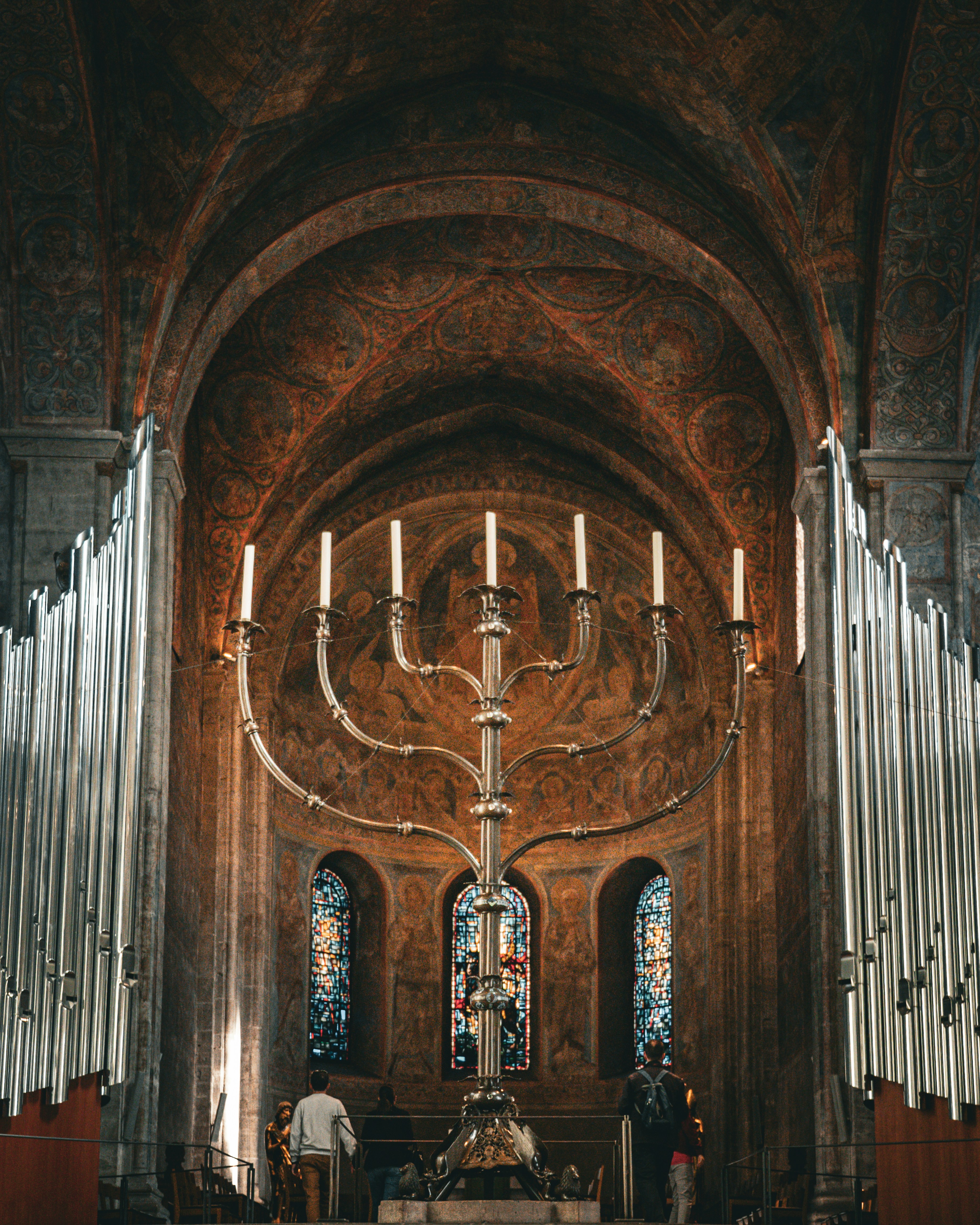 Hallowed Glow: A Candled Altar Niche in a Gothic Nave