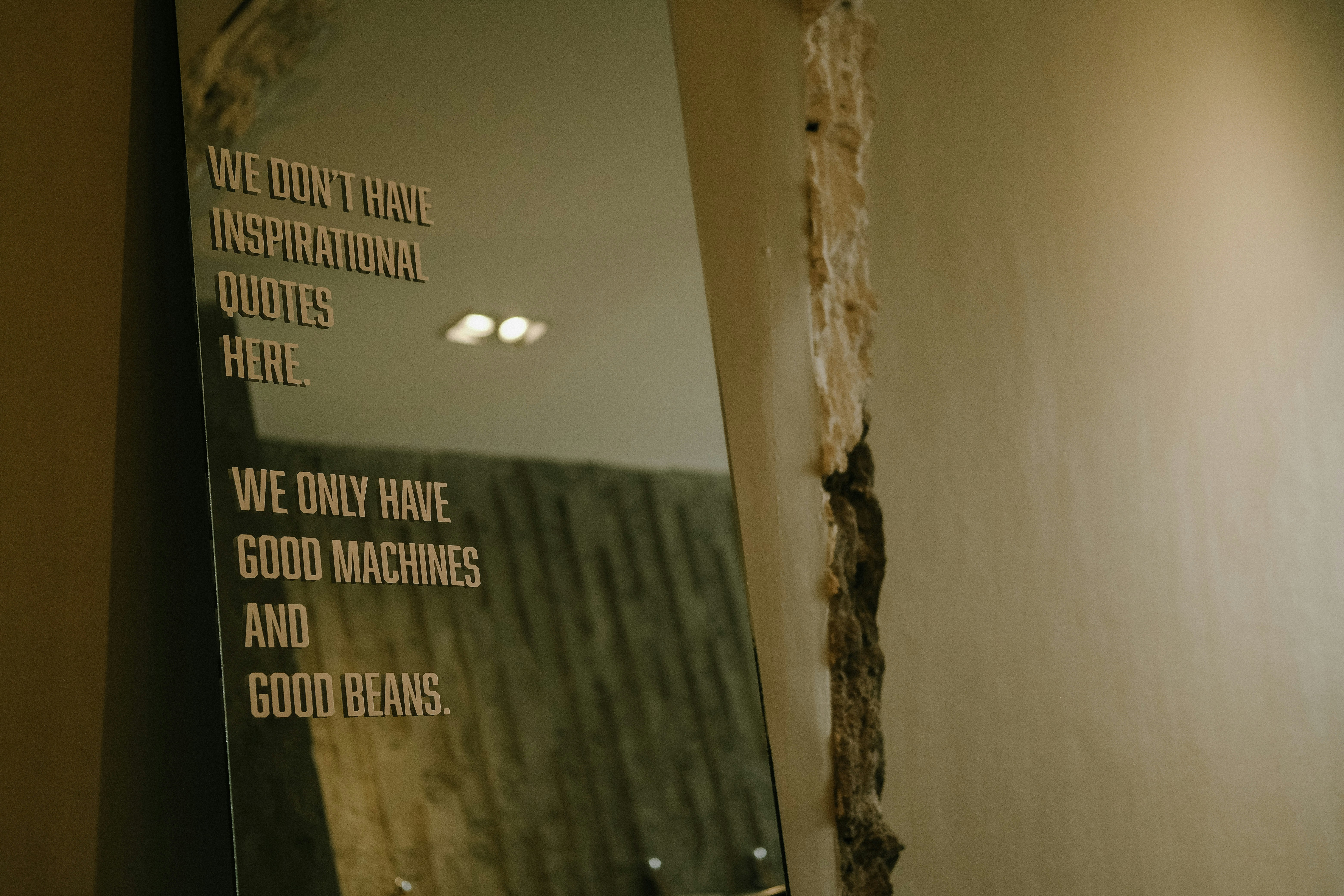 Quotations on a chipped mirror: a fragment of wall and a reflective surface