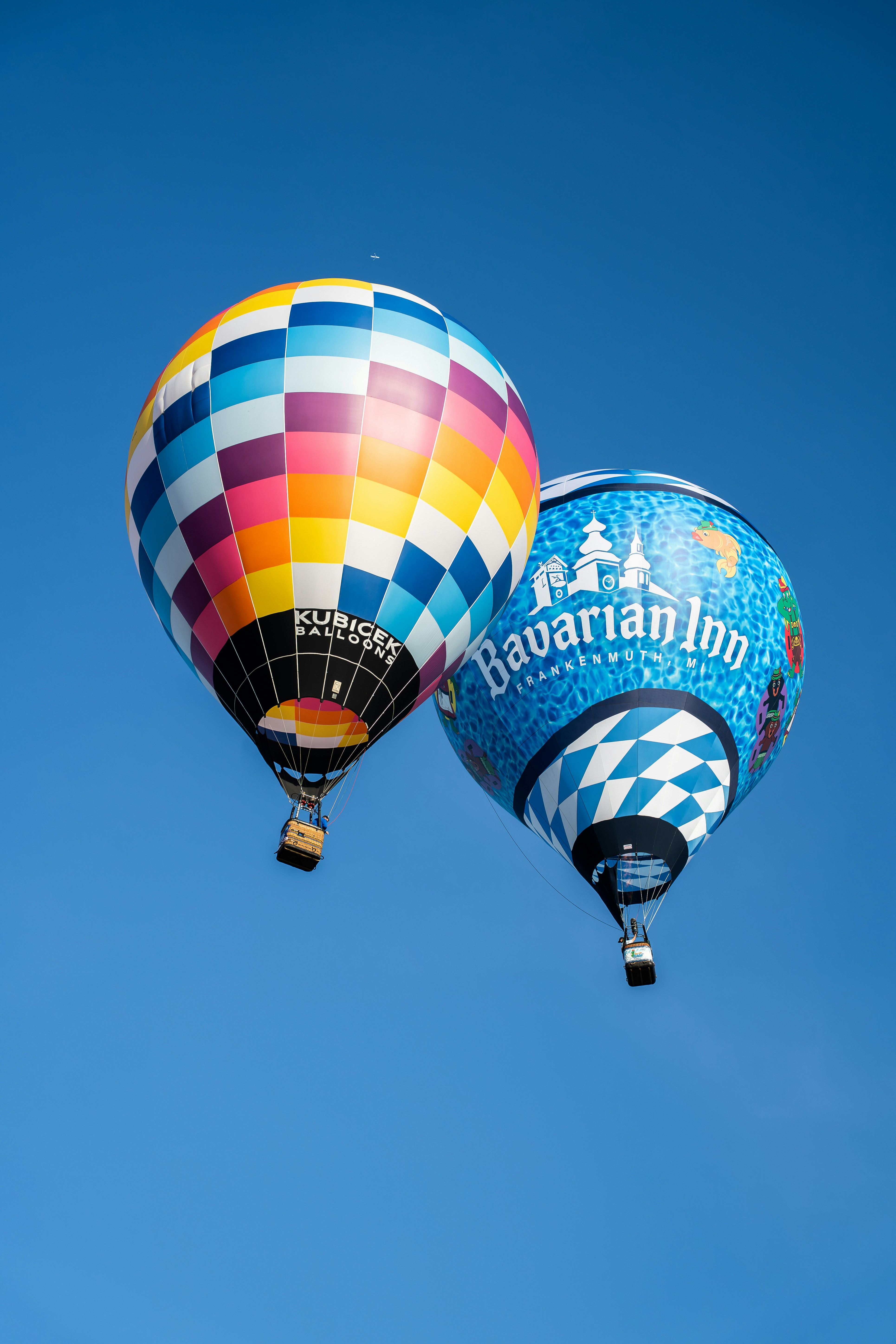 Twin Balloon Ascent Over a Clear Blue Canvas