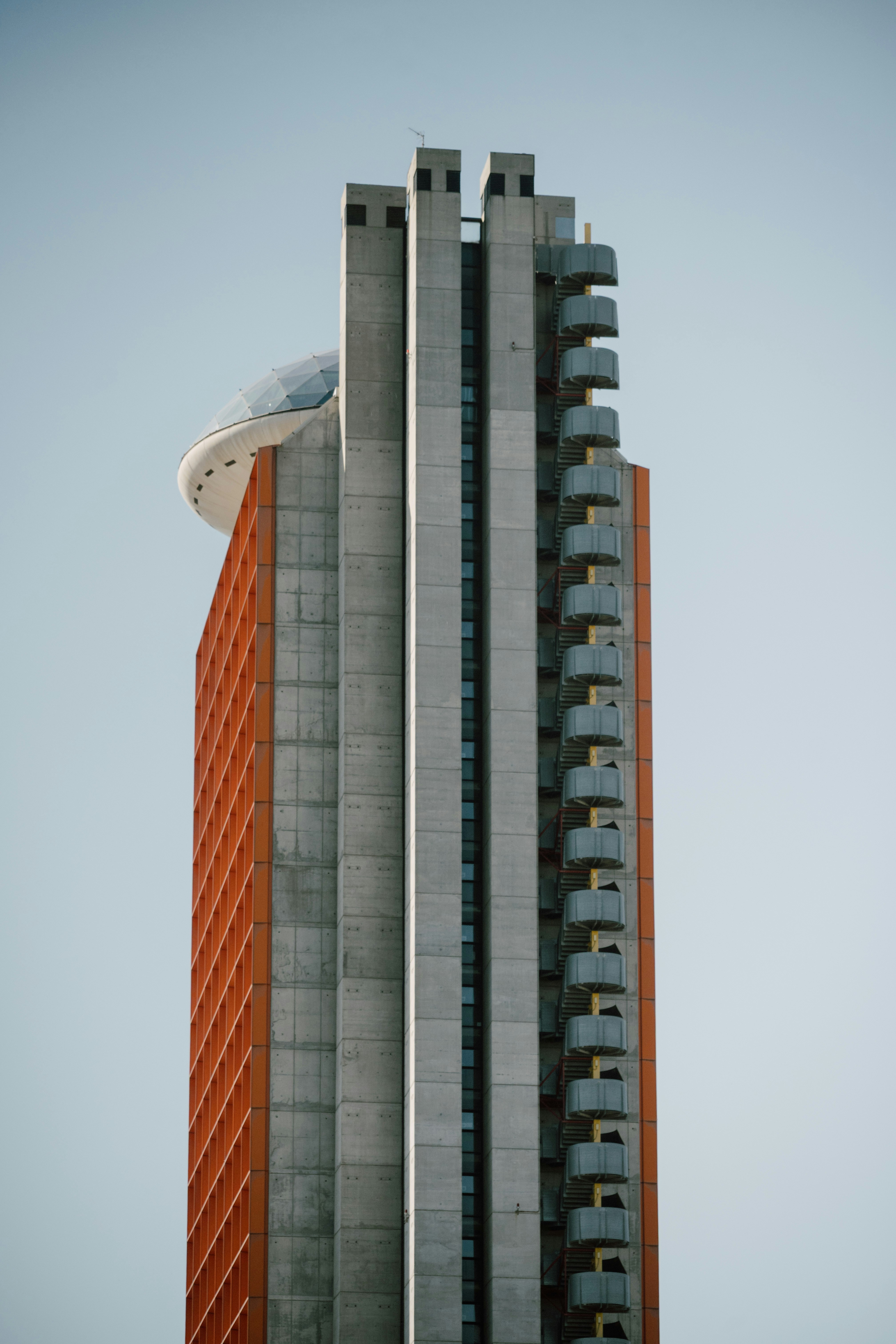 Vertical Megalith: the orange-tinted high-rise with a circular observation pod