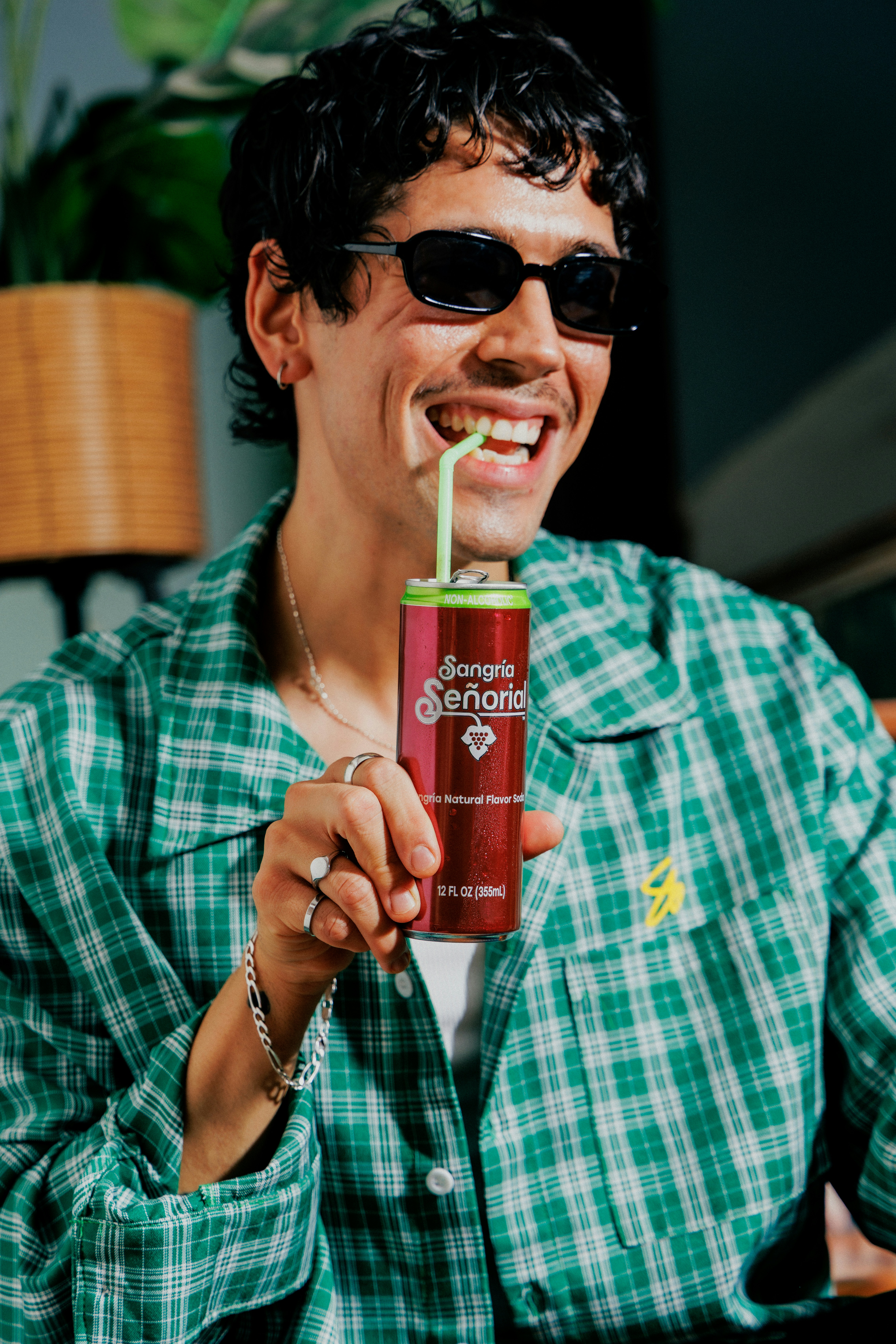 Smiles with a Sip: A Green-Checkered Moment in Sunlit Vibe
