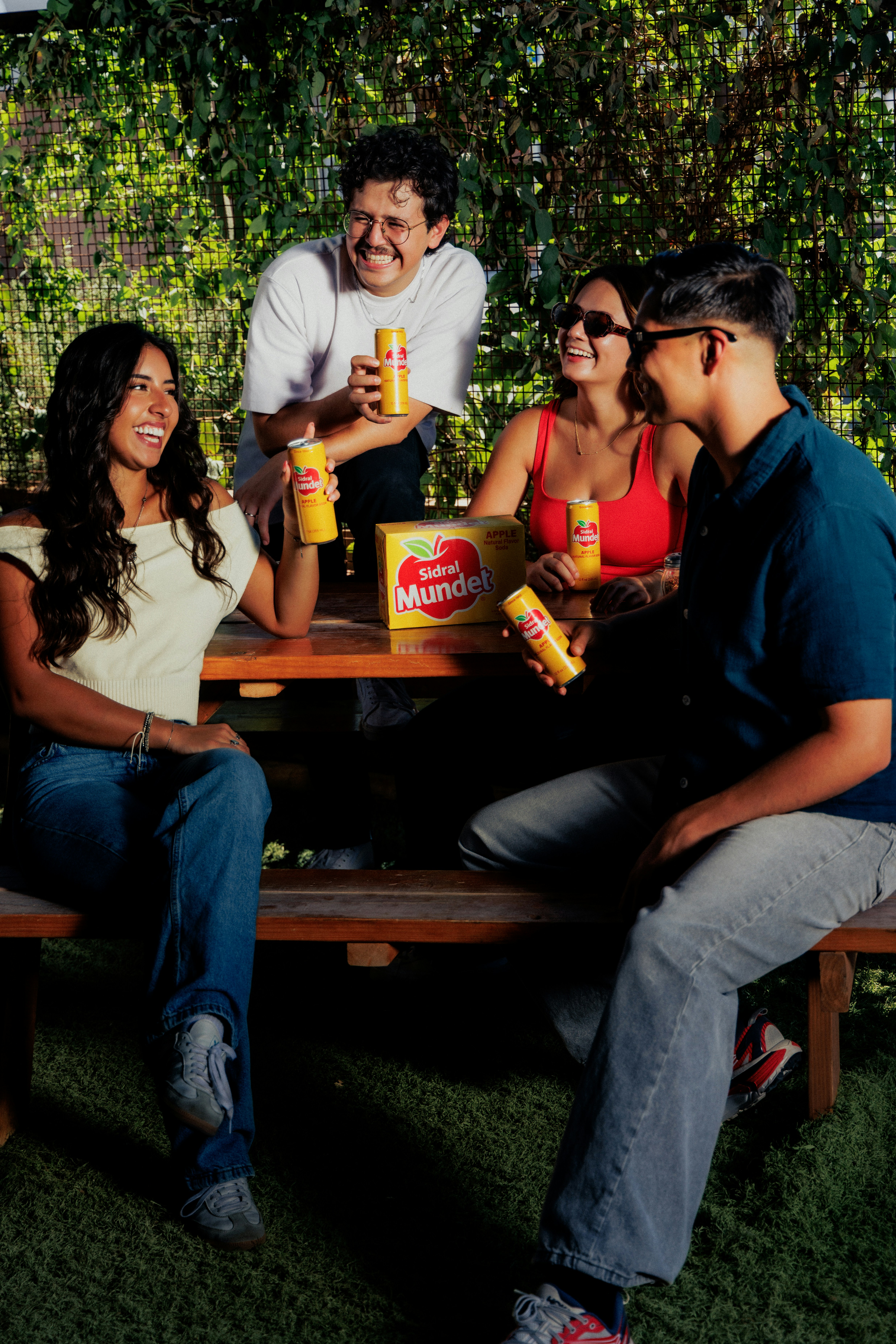 Sunlit Pulse: Friends share a citrus moment under leafy shade