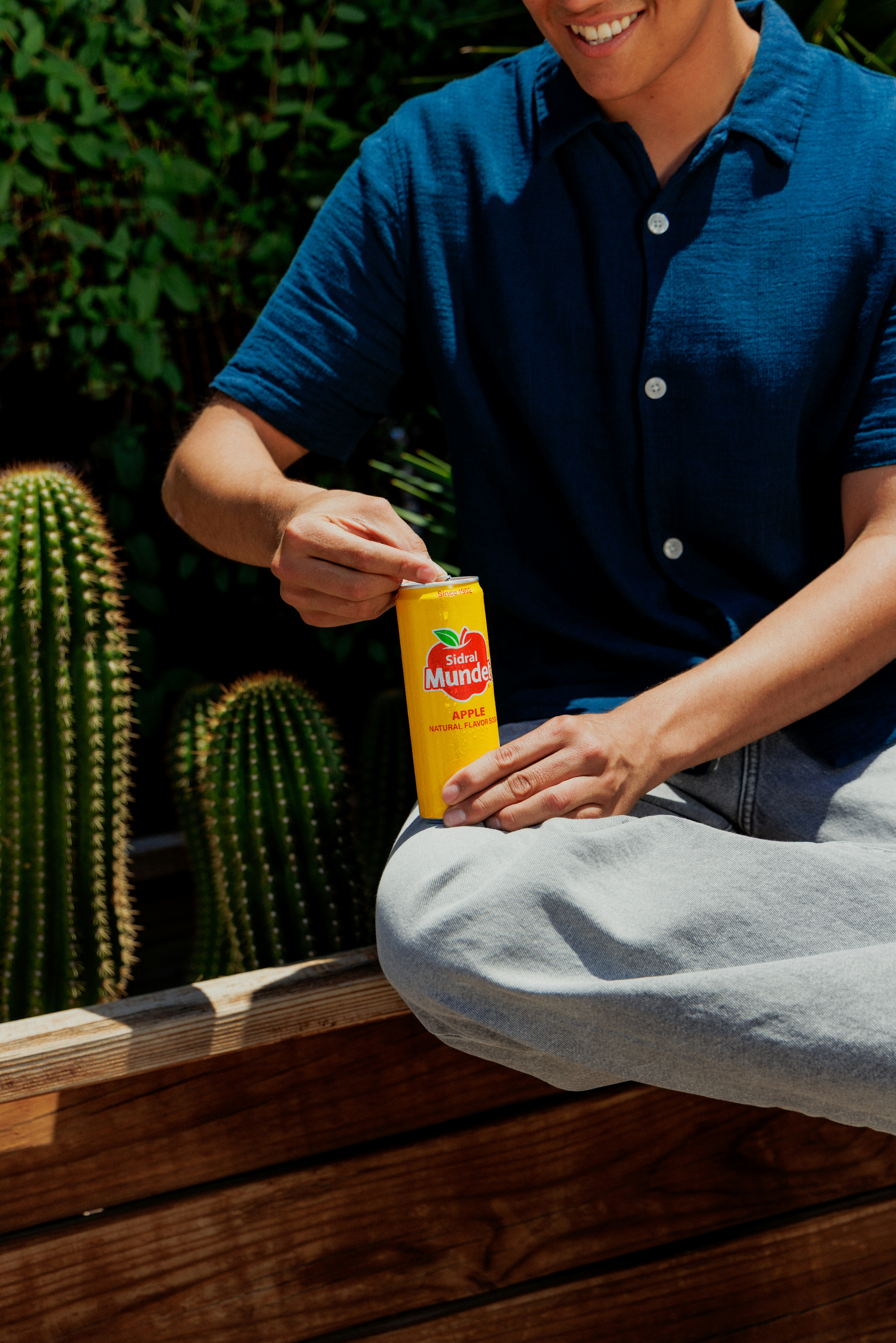 Sunlit Moment: A Youthful Snack Break on the Wooden Bench