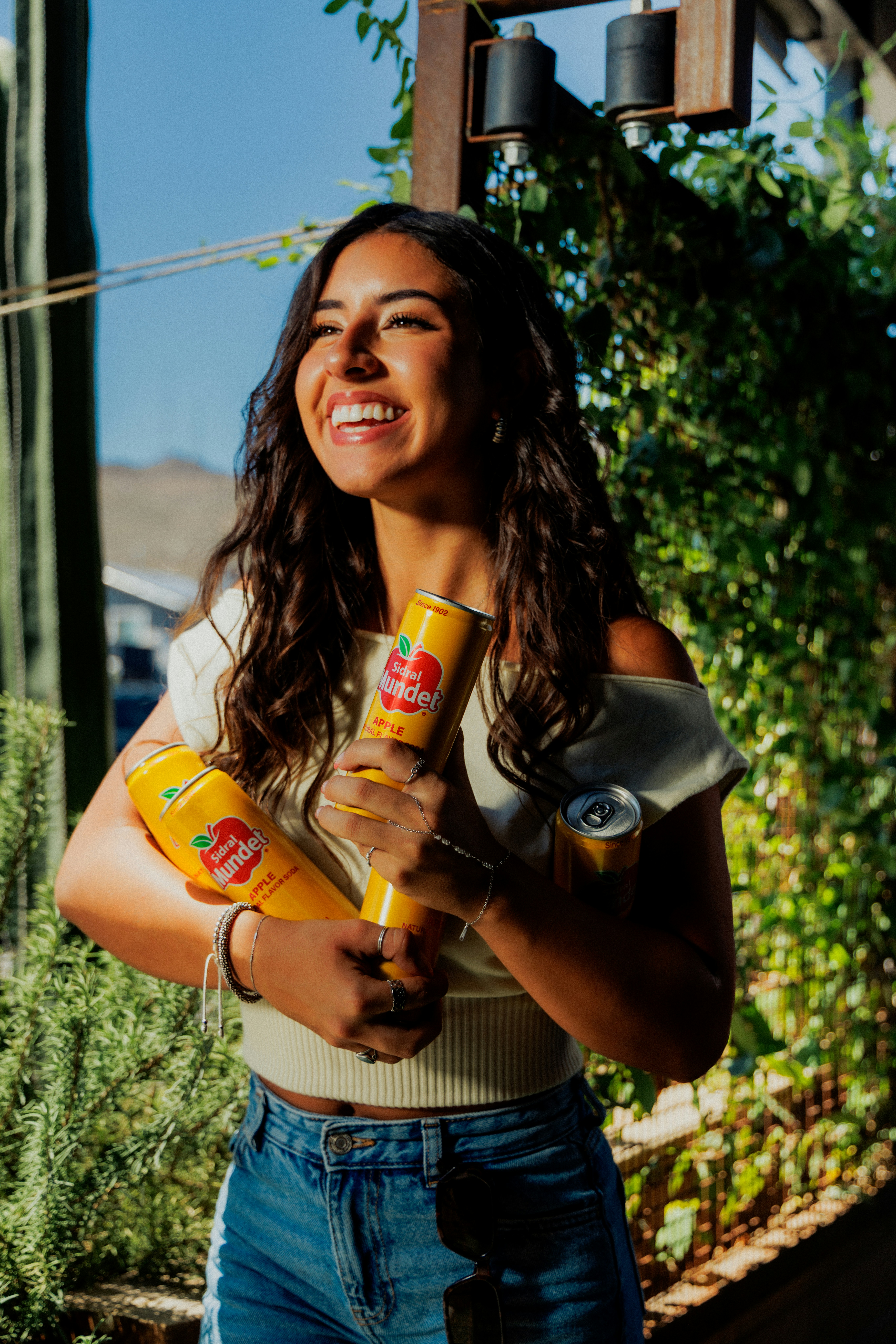 Sunlit Cheer: A joyful moment with cans in hand