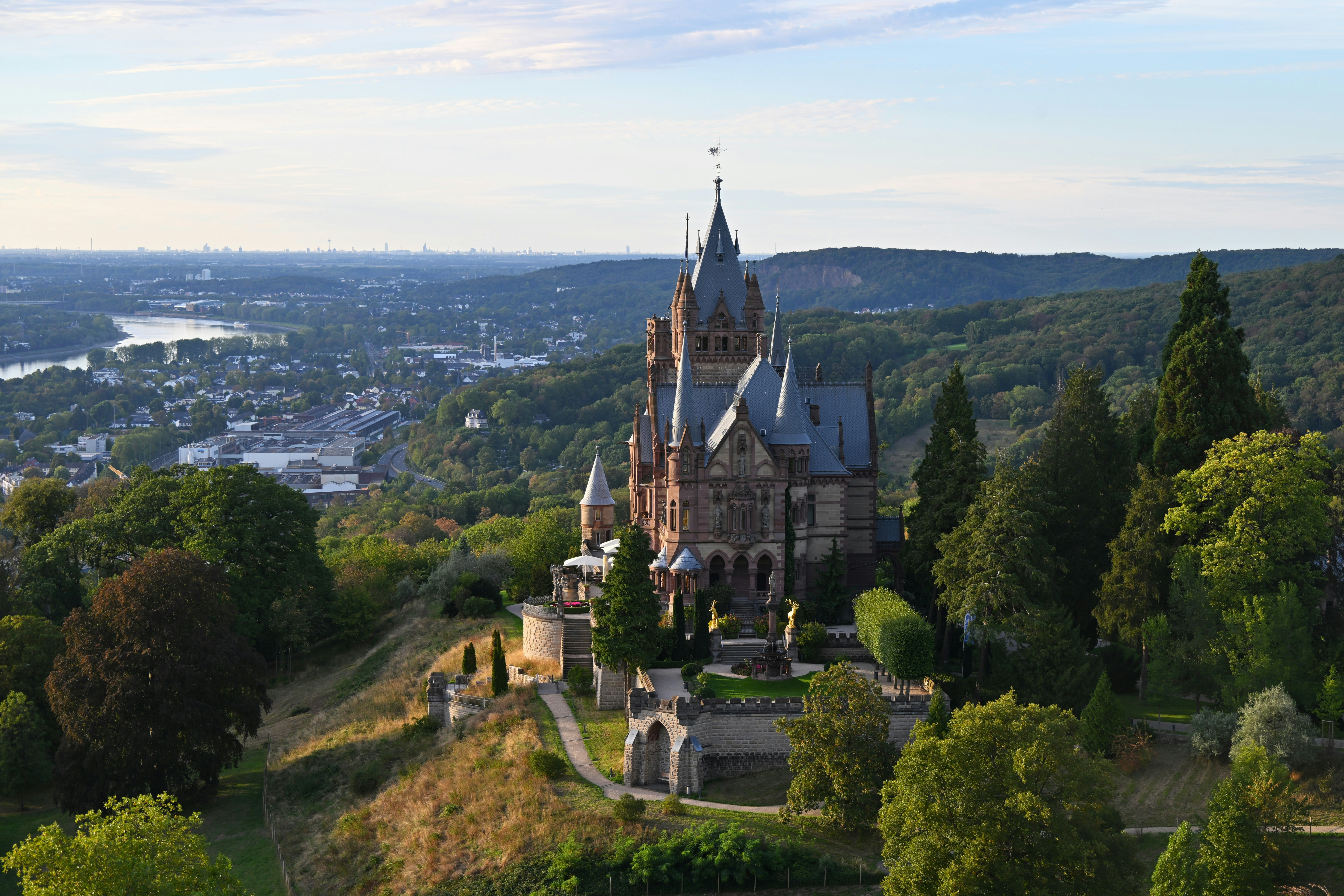 Castle on the Hill: Aerial Sepia Towers Over a Lush Valley
