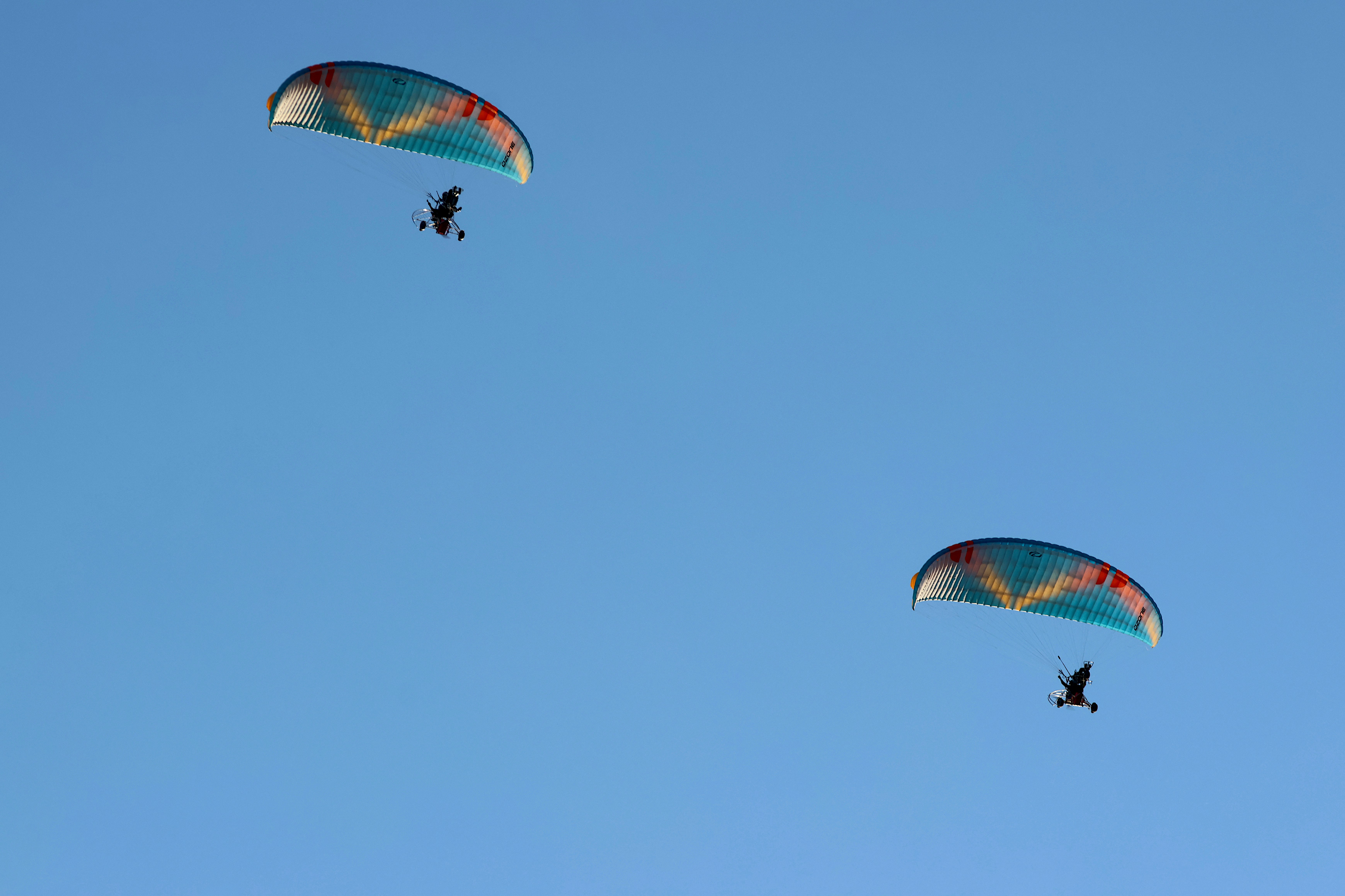 Dual Paragliders Carve Quiet Blue Skies