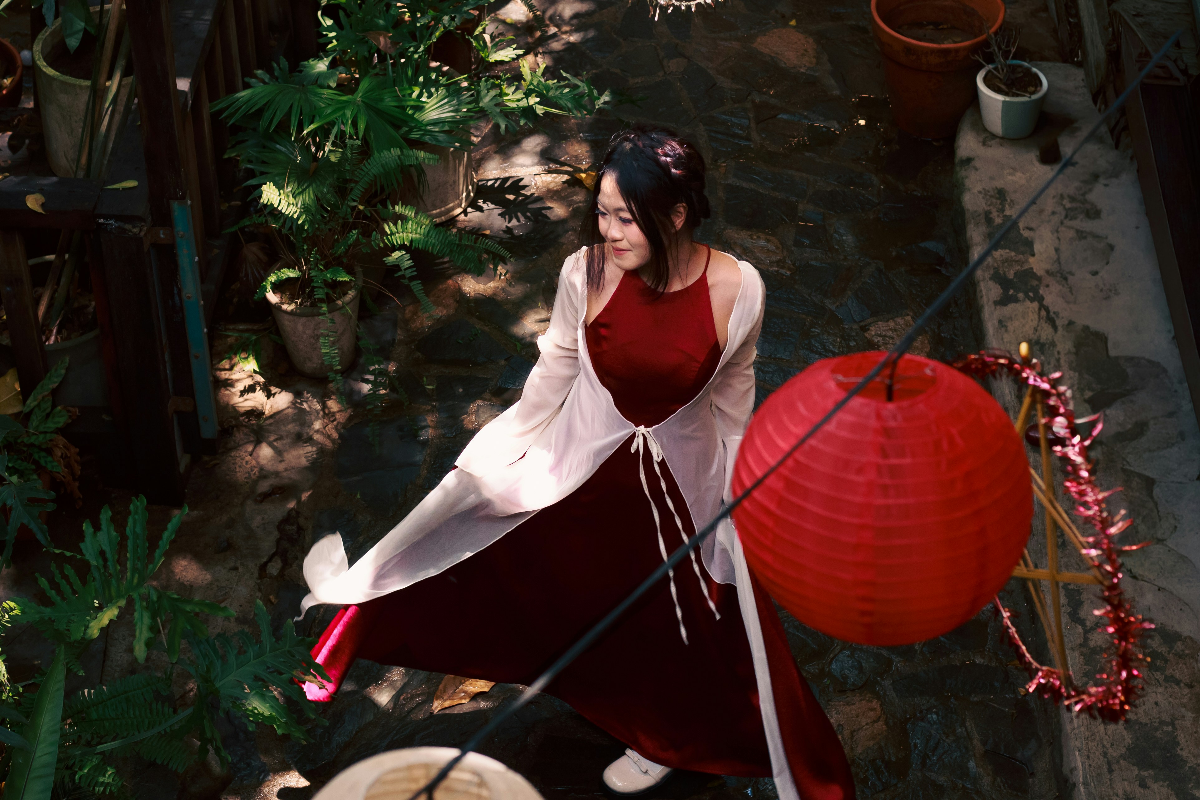 Red Dress in the Courtyard: A Quiet Moment of Grace