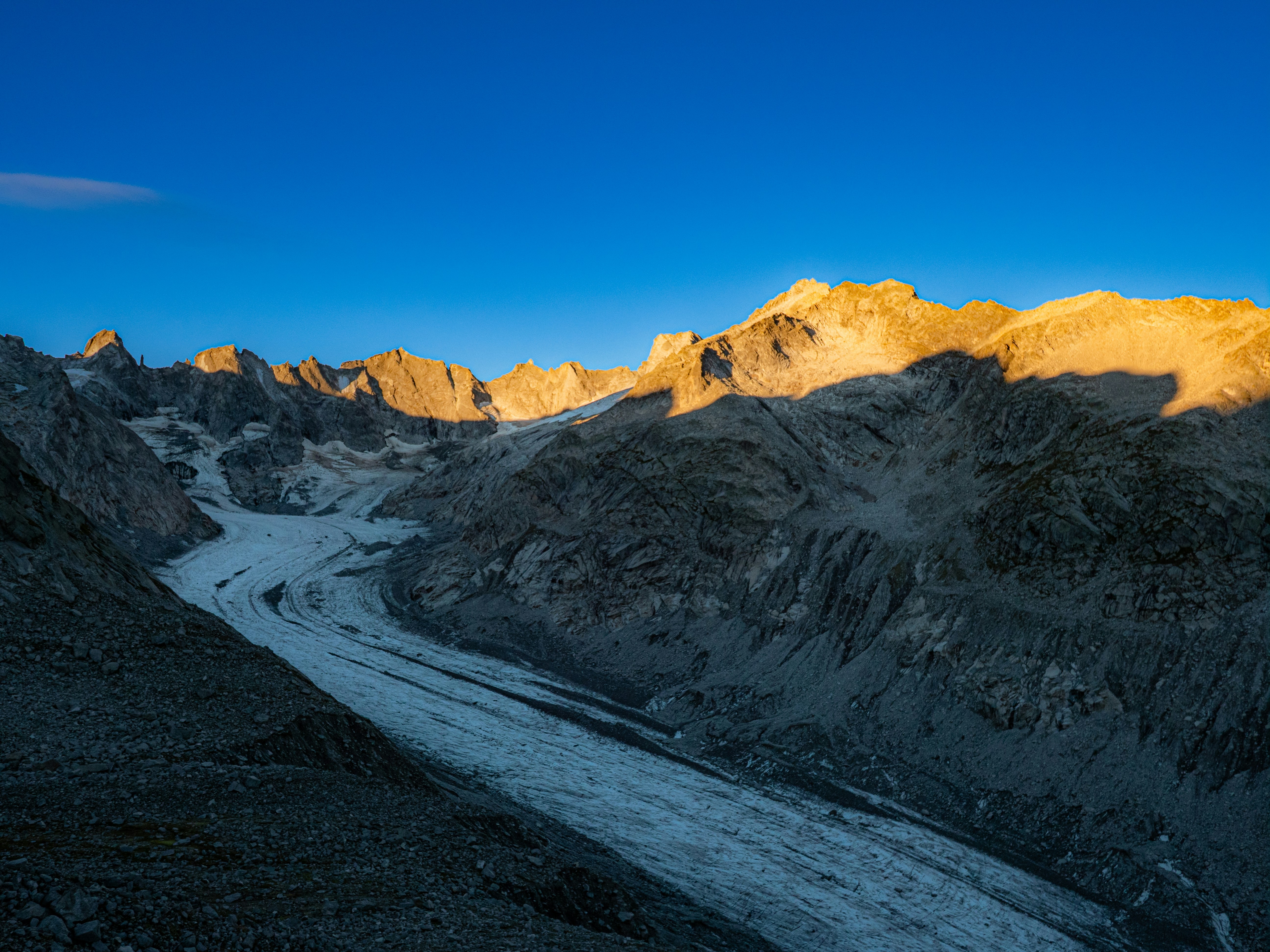 Golden Summit: Canyon of Ice under a Blue Dome