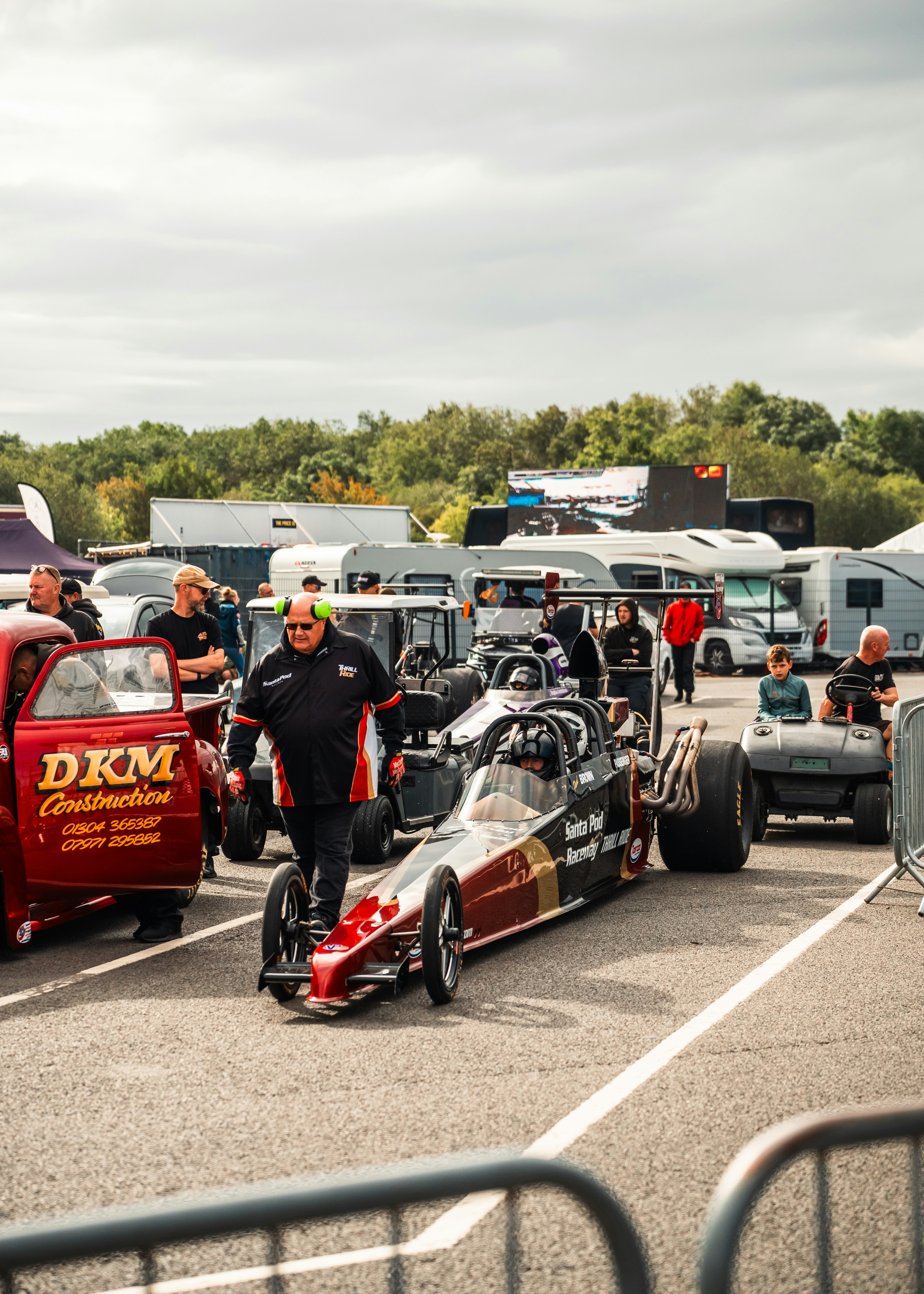 Pole Position: Sprint Car on the Grid under a GATHERING of Crew and Trailers
