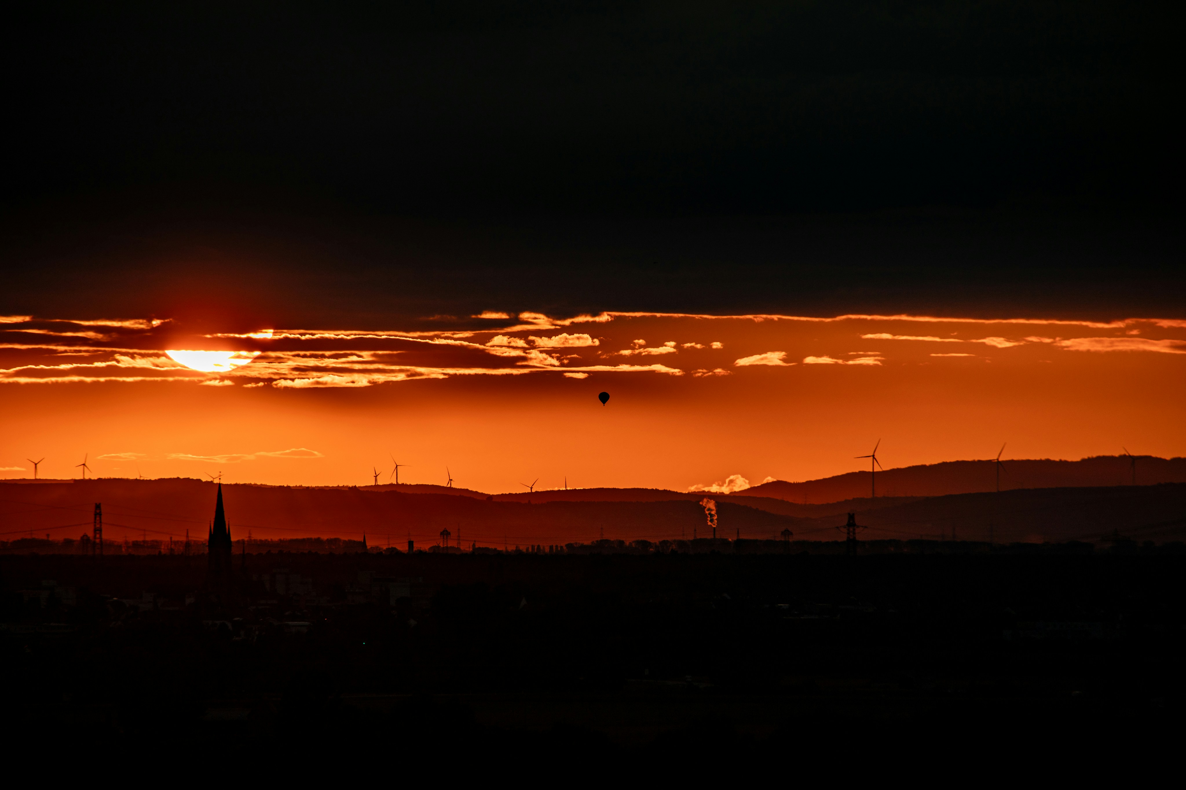 Low Sun, High Horizon: A Quiet Dusk Over Distant Wind Turbines
