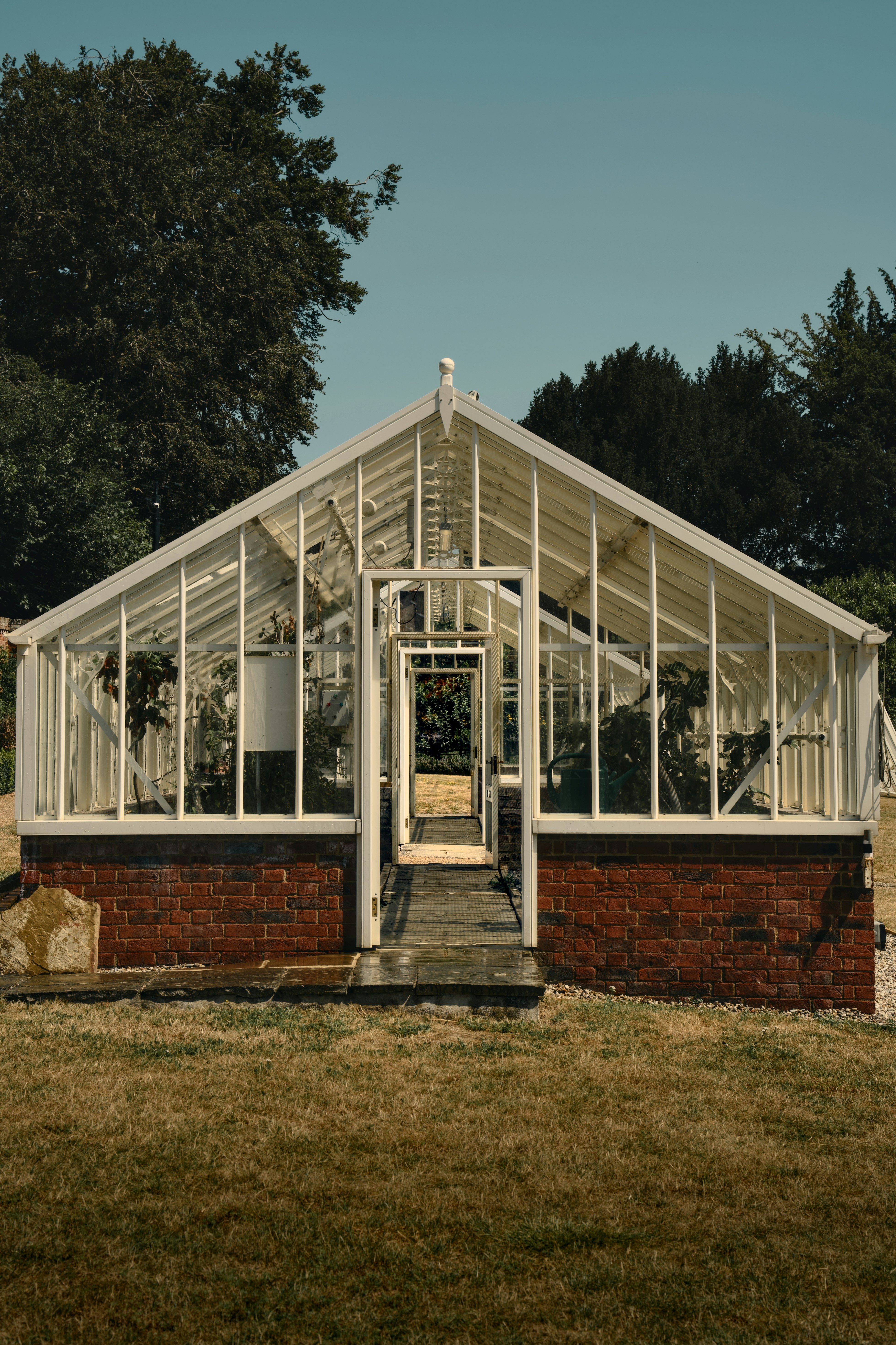 Glass Cathedral: A Central Greenhouse Framed by Brick Baseline