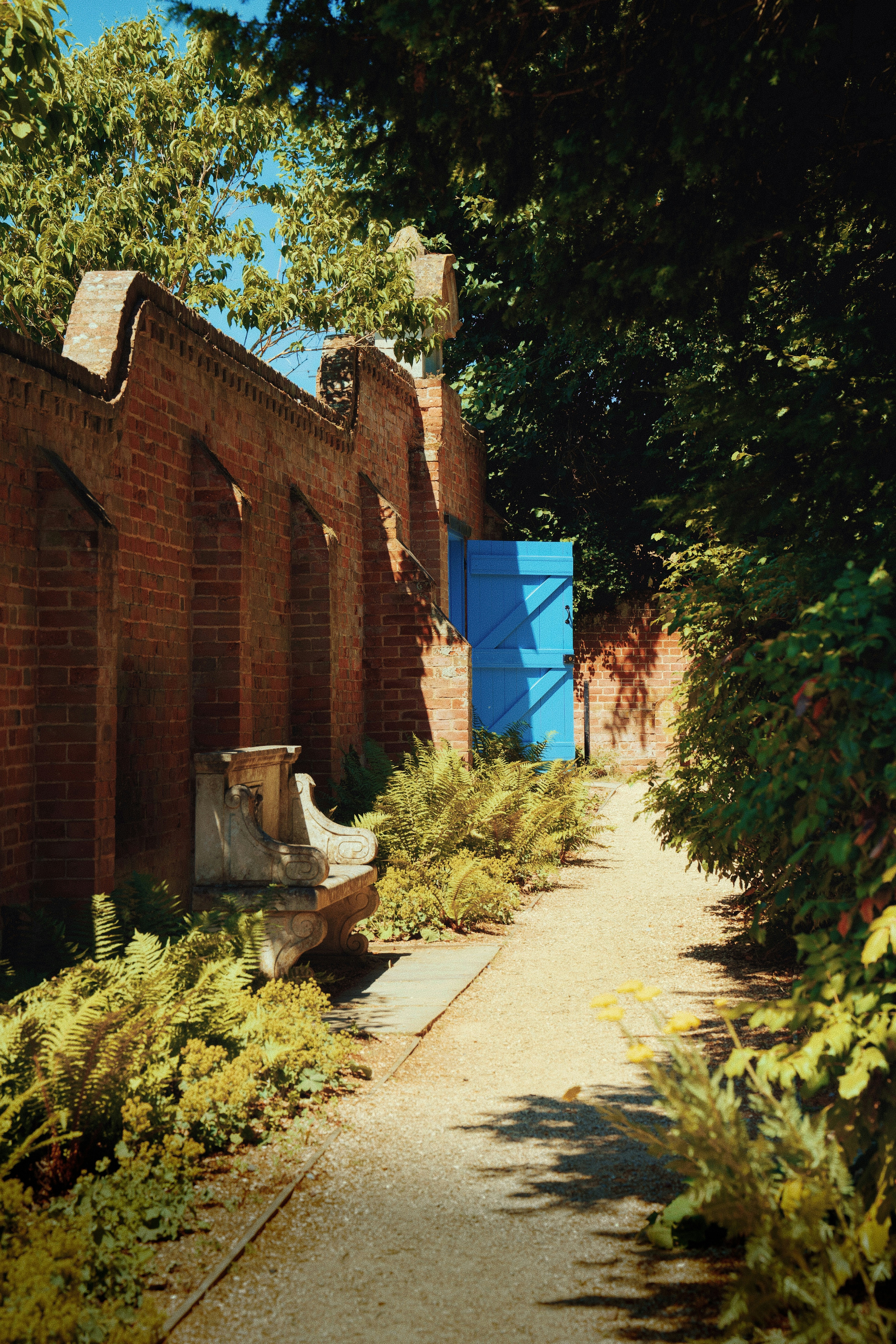 Azure Gate in a Sunlit Brick Corridor