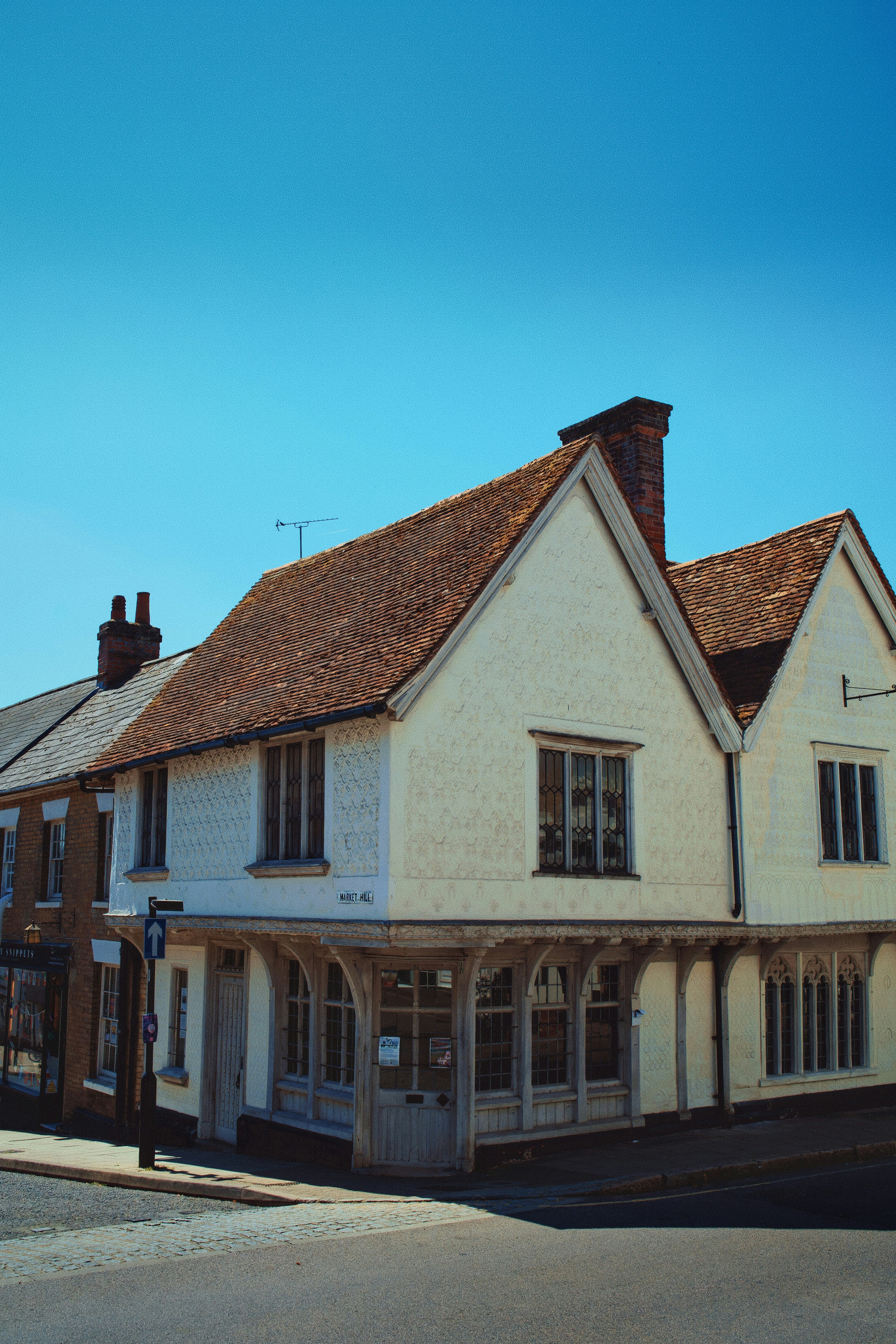 Cornerstone in Sunlit Angle: A Historic Shopfront Basks in Noon Light