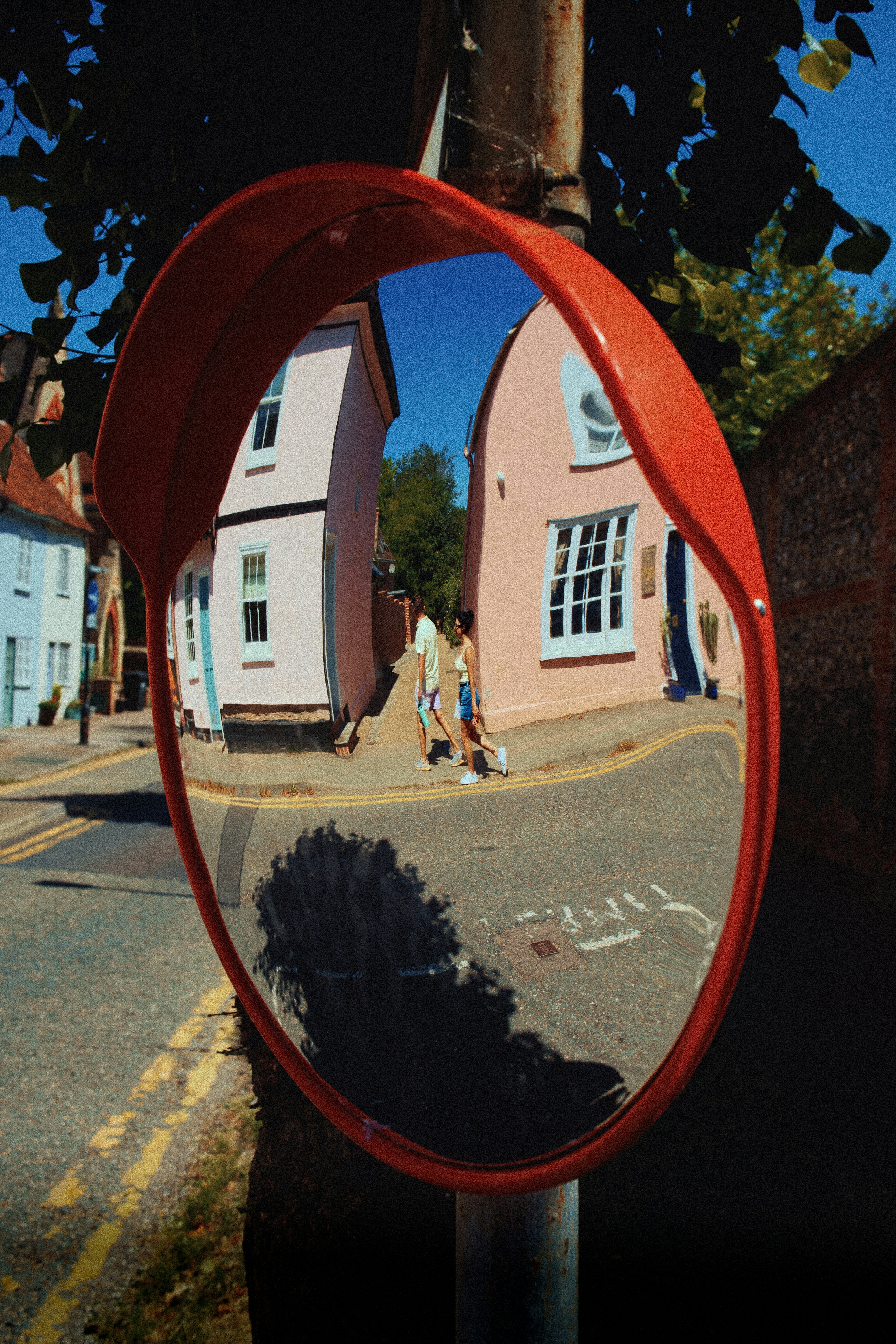 Reflected Street Portrait in a Red Circular Mirror