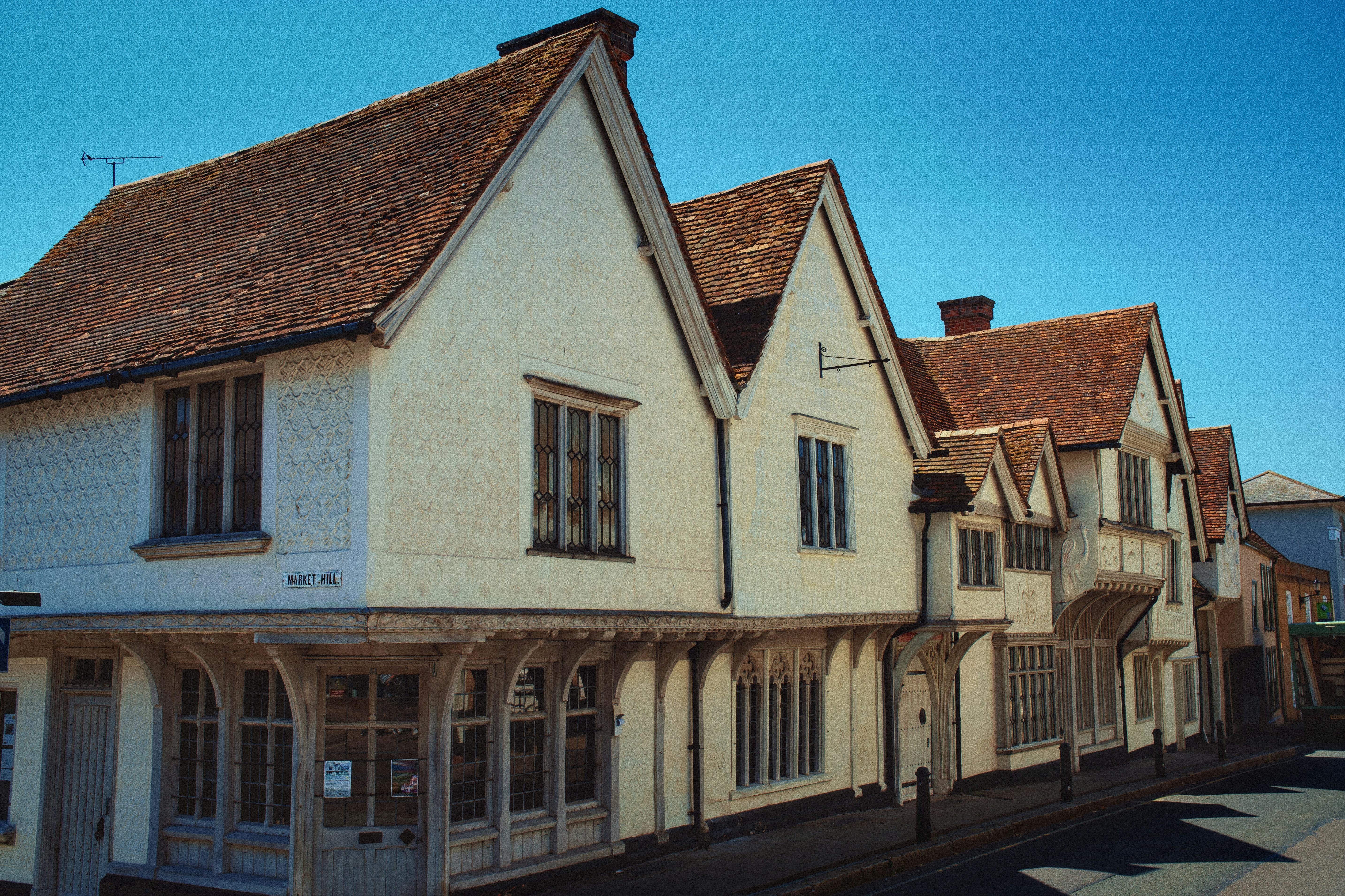 Quaint Cheshire Row: Sunlit White Facades and Red-Tiled Rooftops
