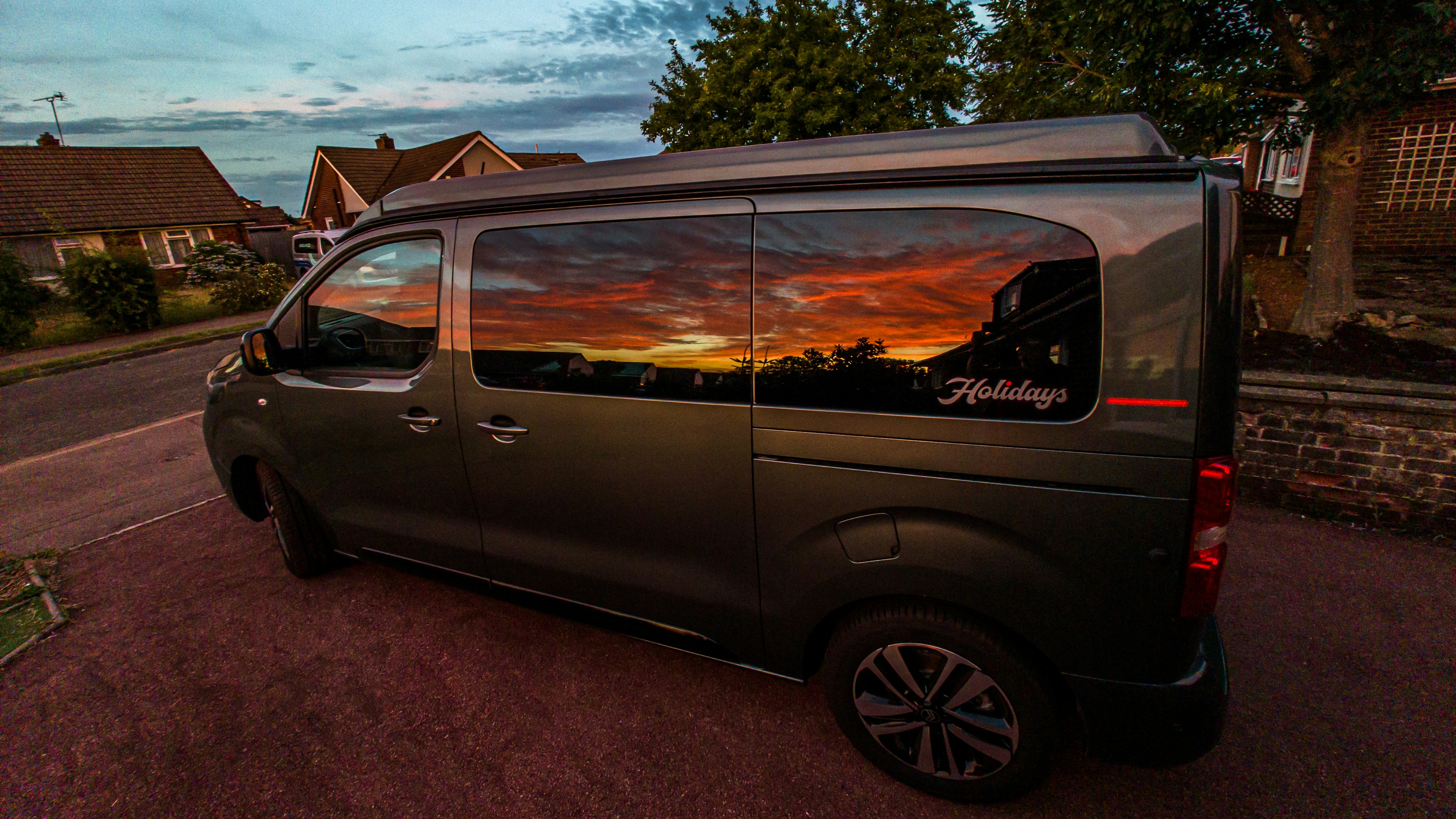 Citroen spacetourer holidays Campervan with a sunset reflection in the limo tinted glass windows