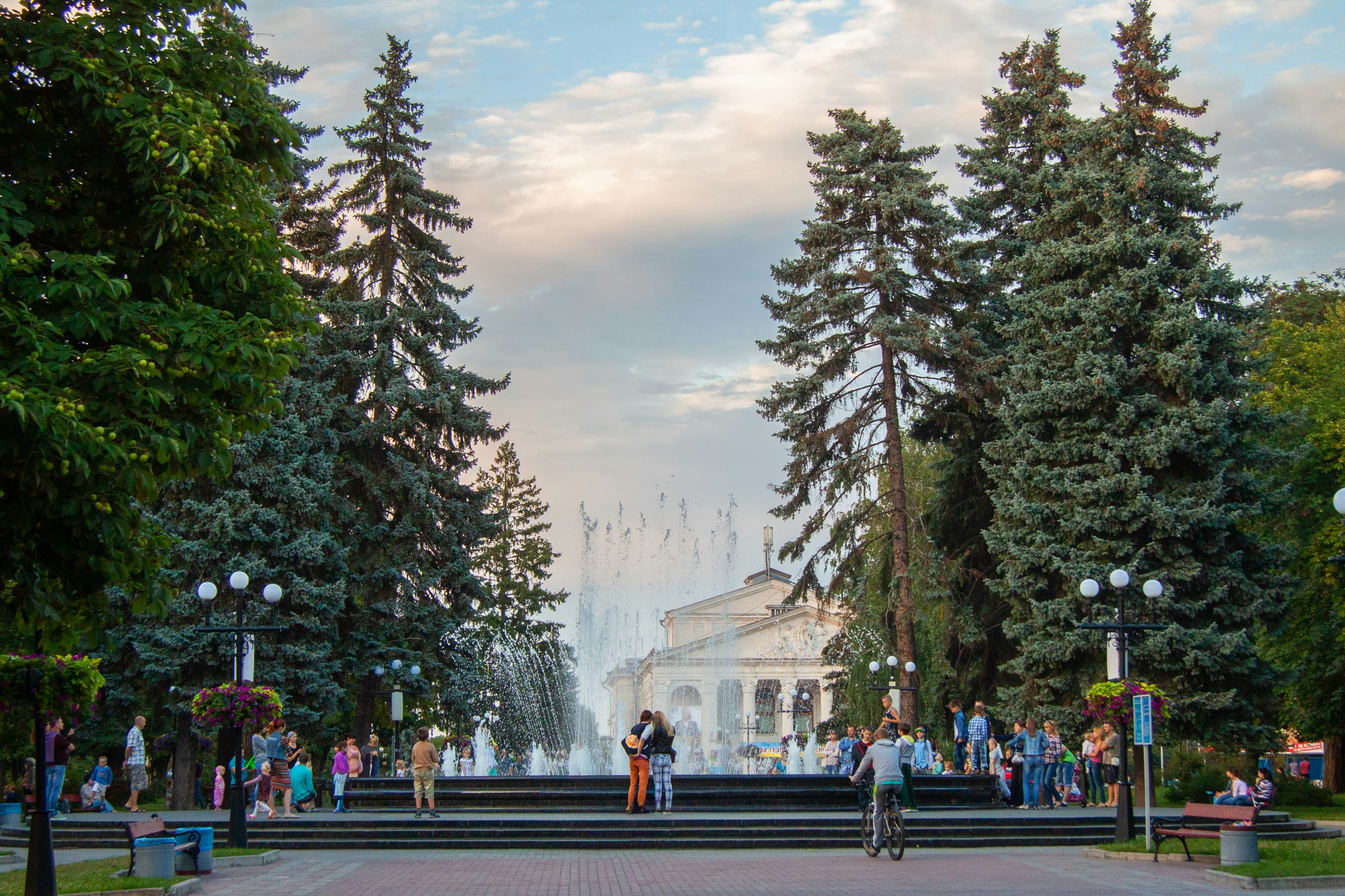 Fountain Symphony: People Gathered Around a Central Water Spout