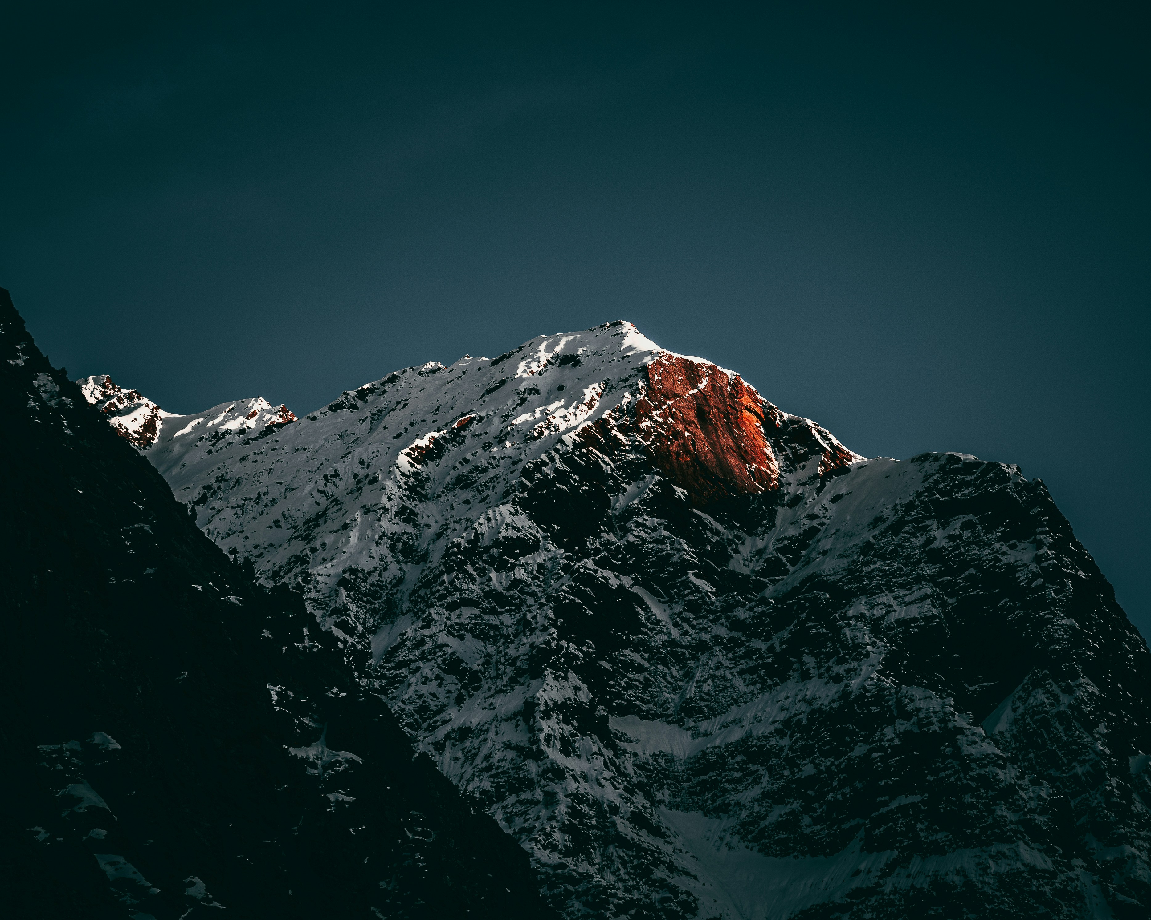 Red-tinged summit under a cobalt sky