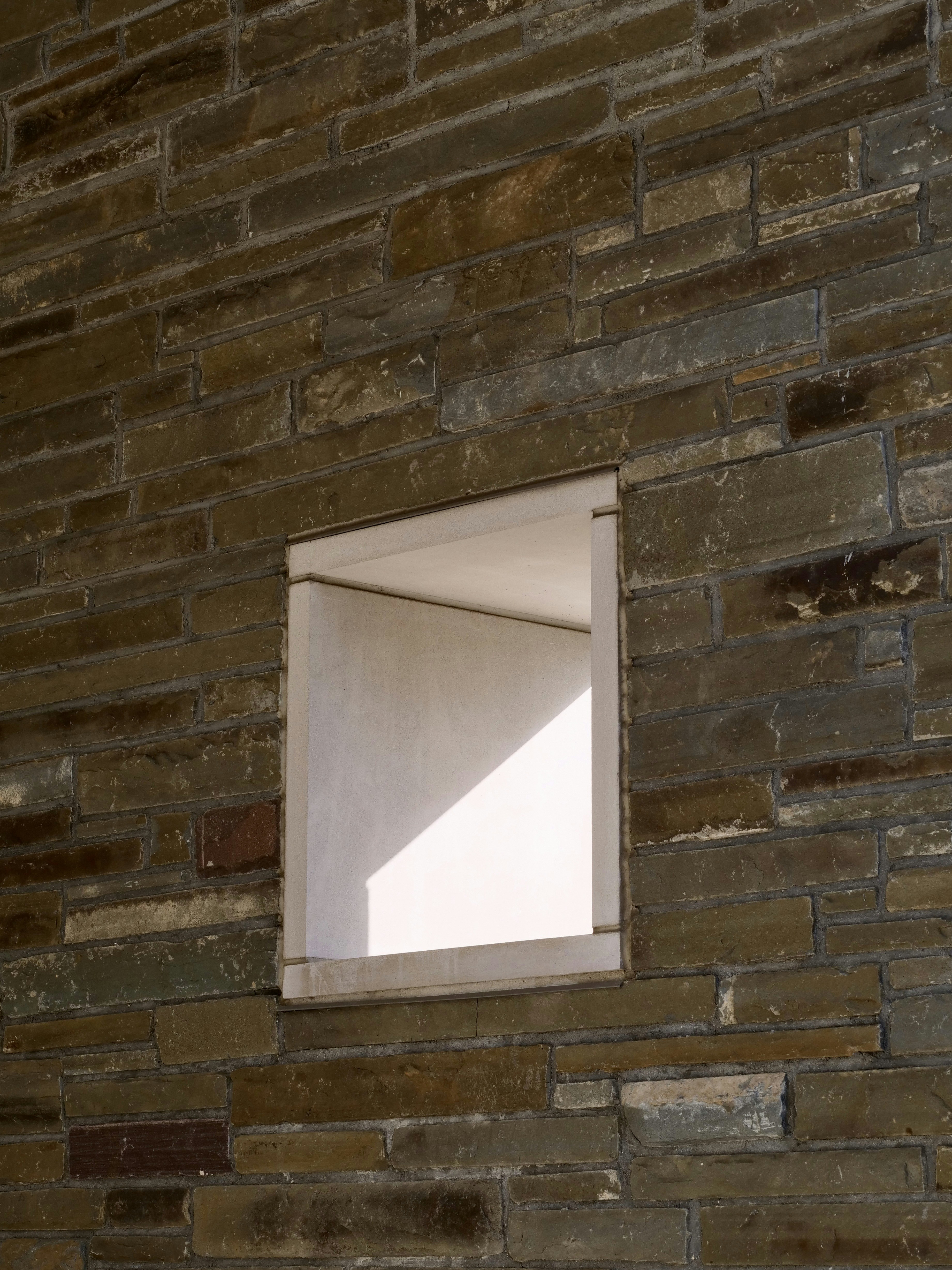Hidden Window Glimpse in Weathered Brick