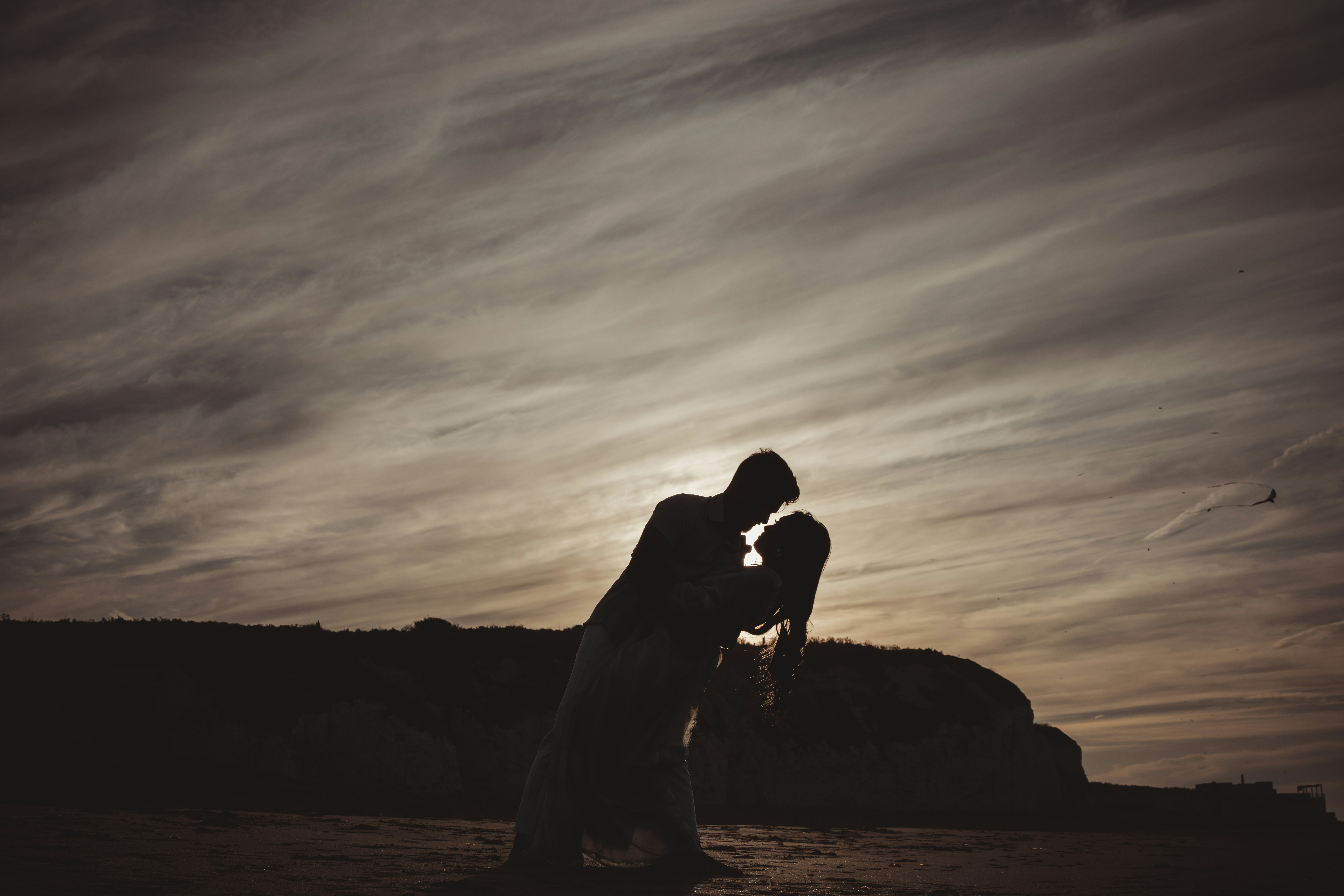 Sunset Embrace: A Silhouette Kiss on the Shore