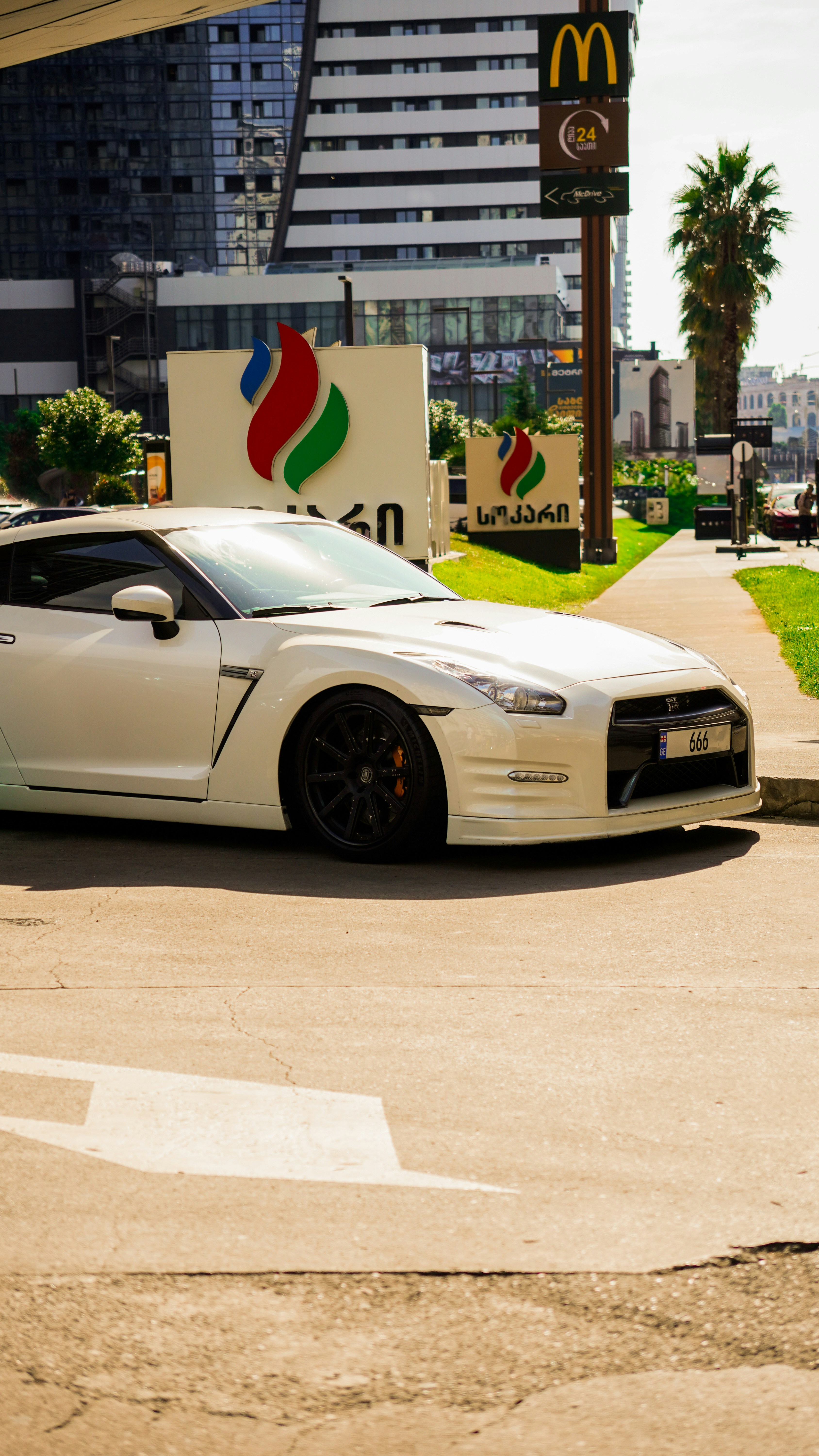 White Nissan GT-R at a Modern Downtown Corner