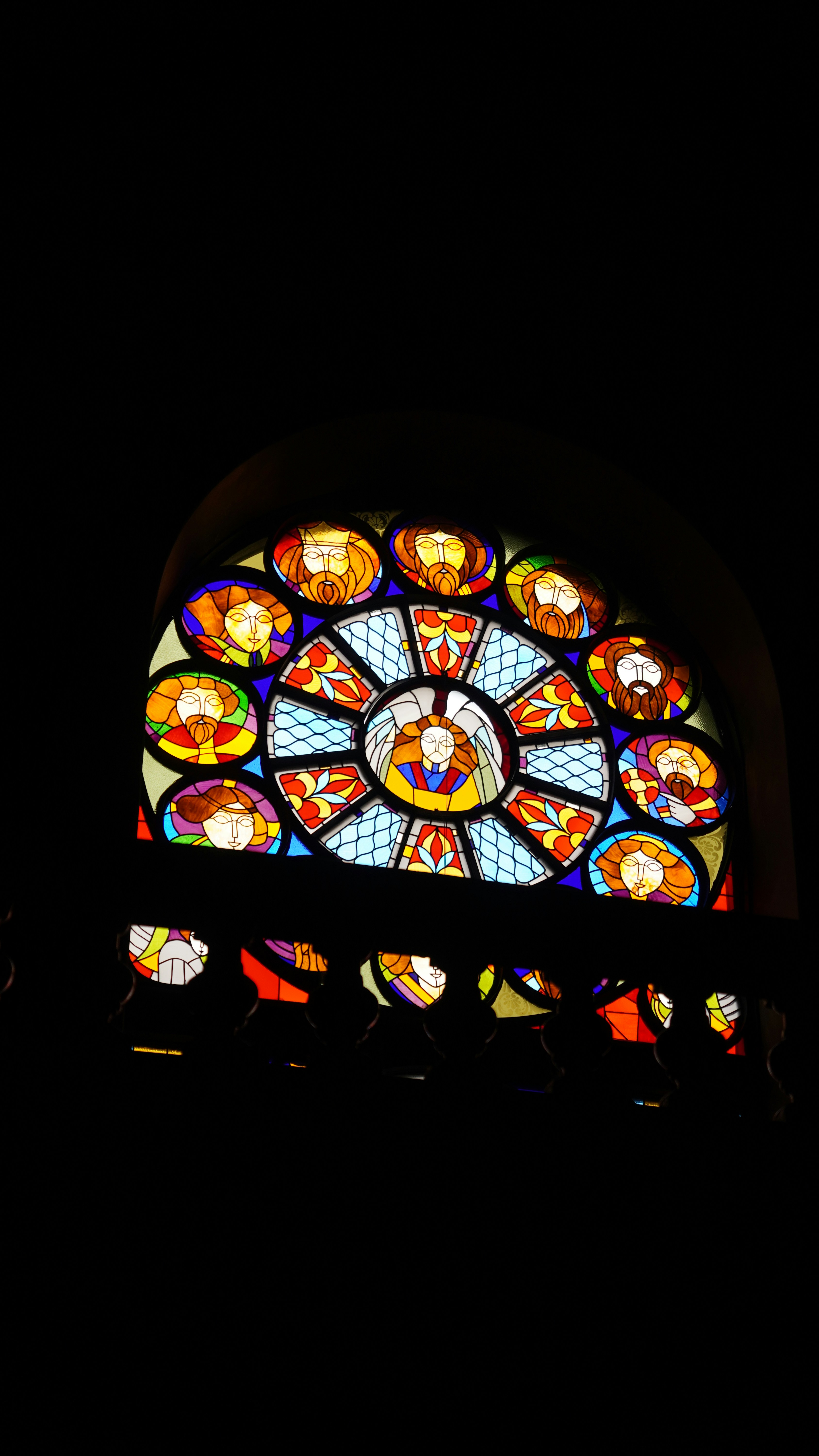 Stained Glass Halo: Circular Window of Faces