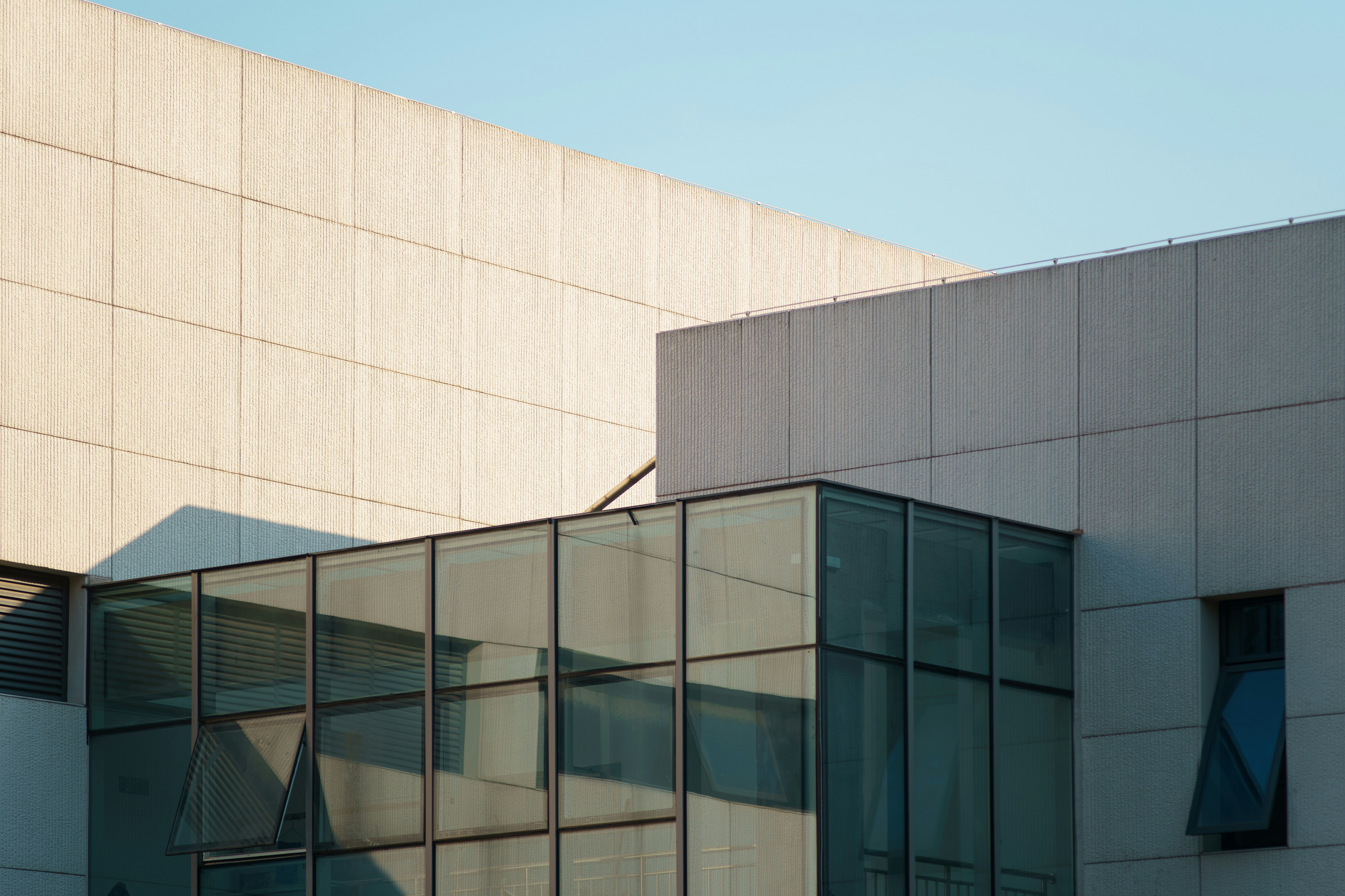 Glass Facade Reflections on a Geometric Modernist Corner