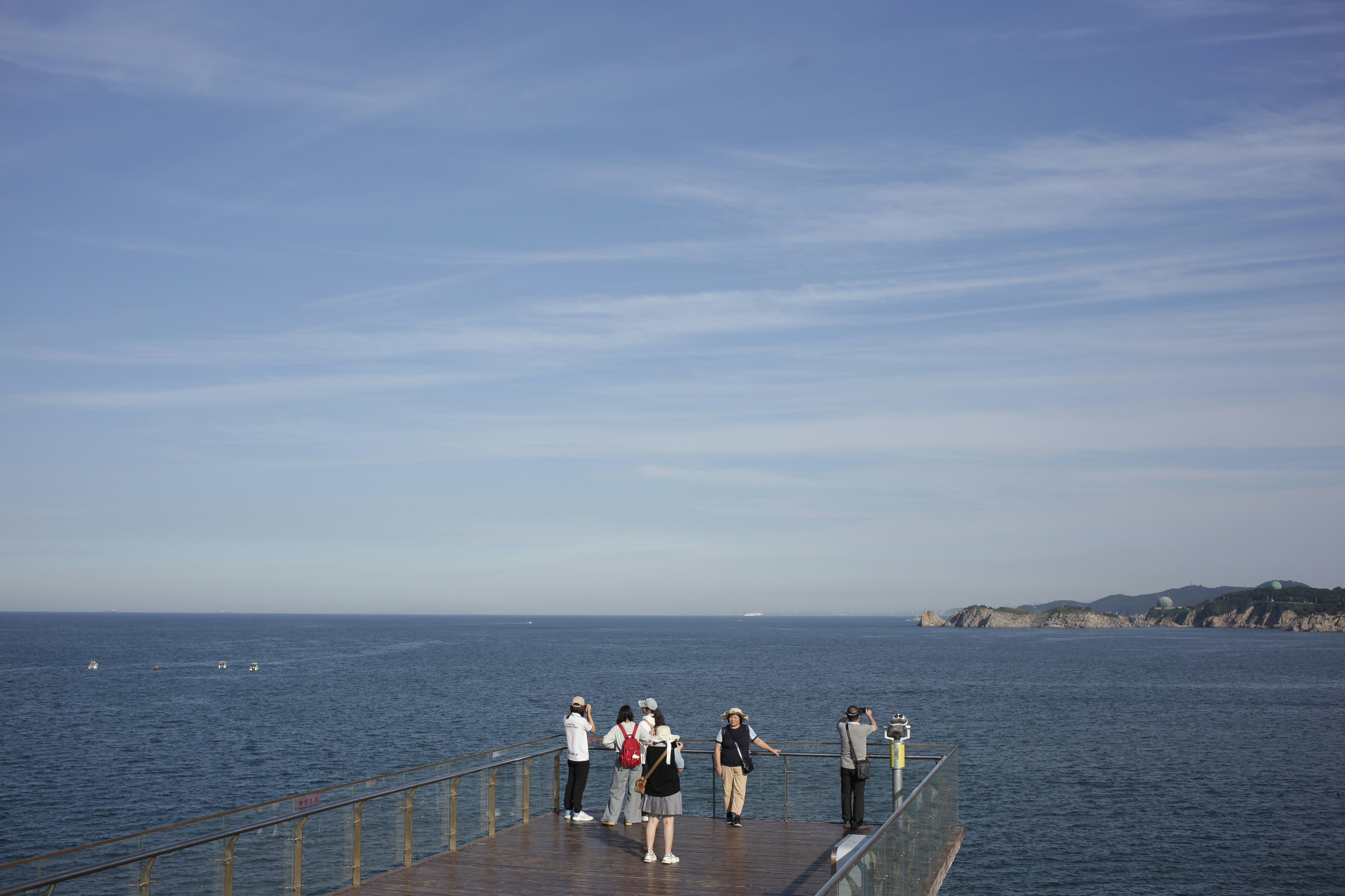Pier to the Horizon: A Lonely Platform of People Over the Sea
