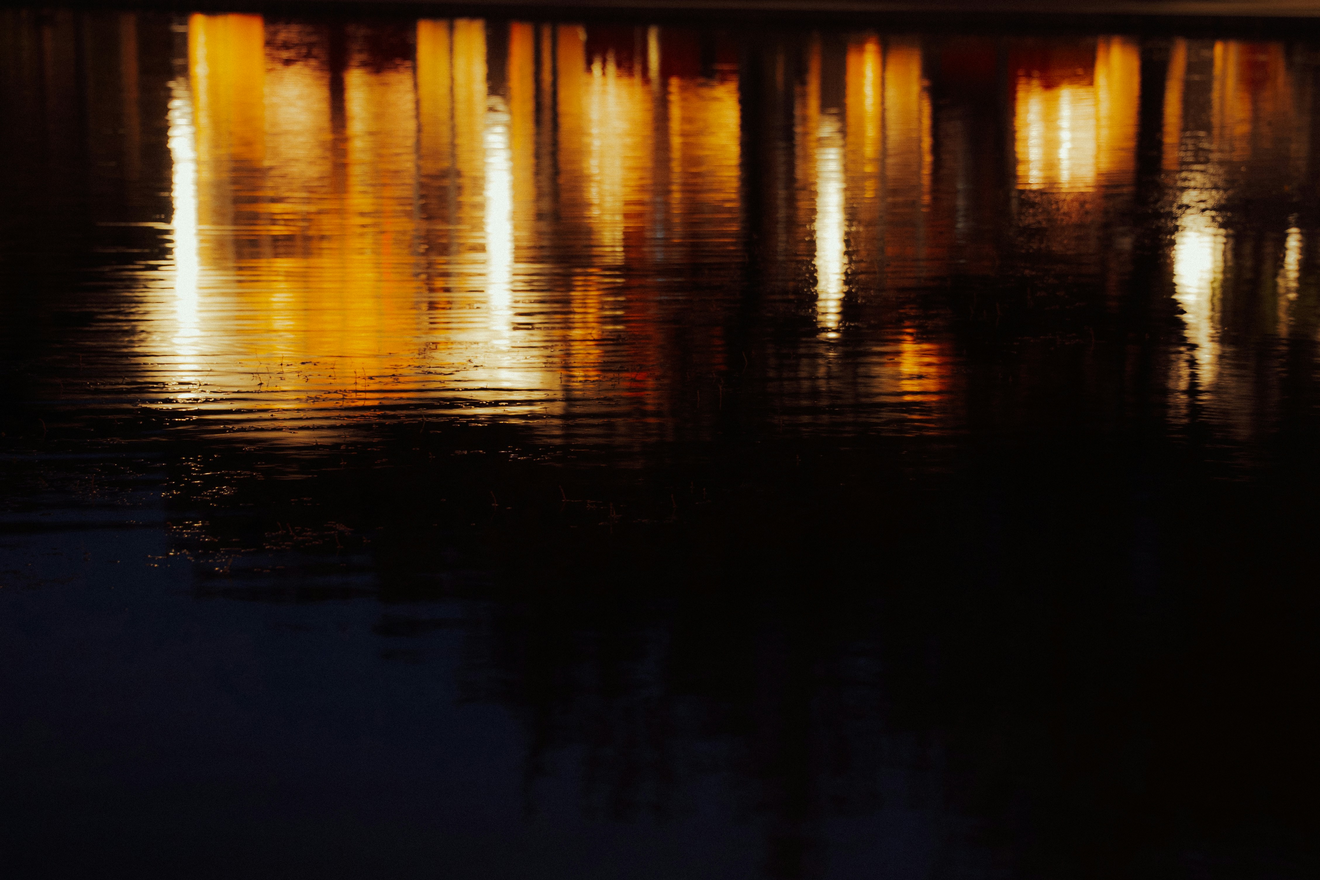Golden Ripples: City Lights on a Quiet River