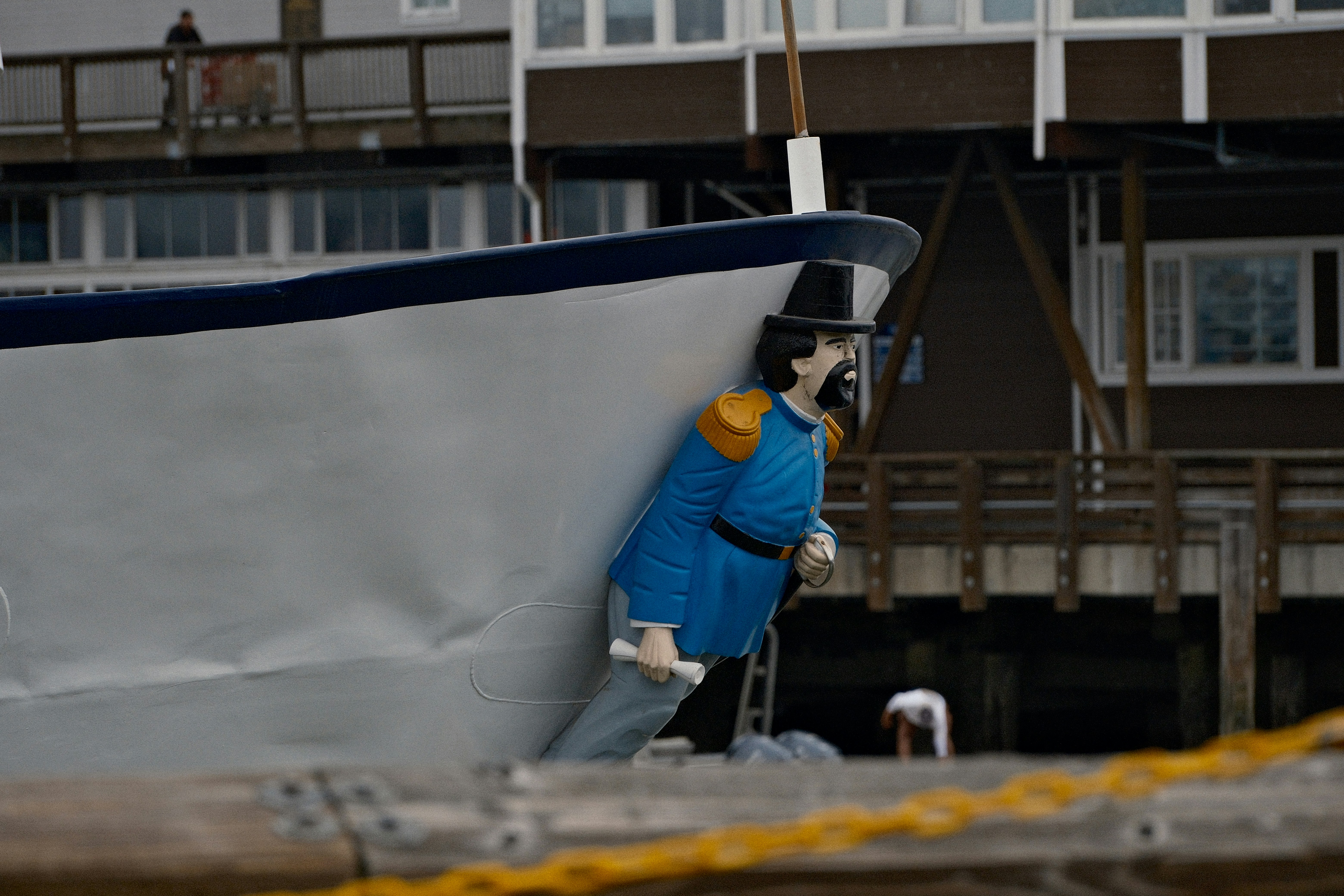 Boat Bow Portrait: A Static Figure Guarding the Quay