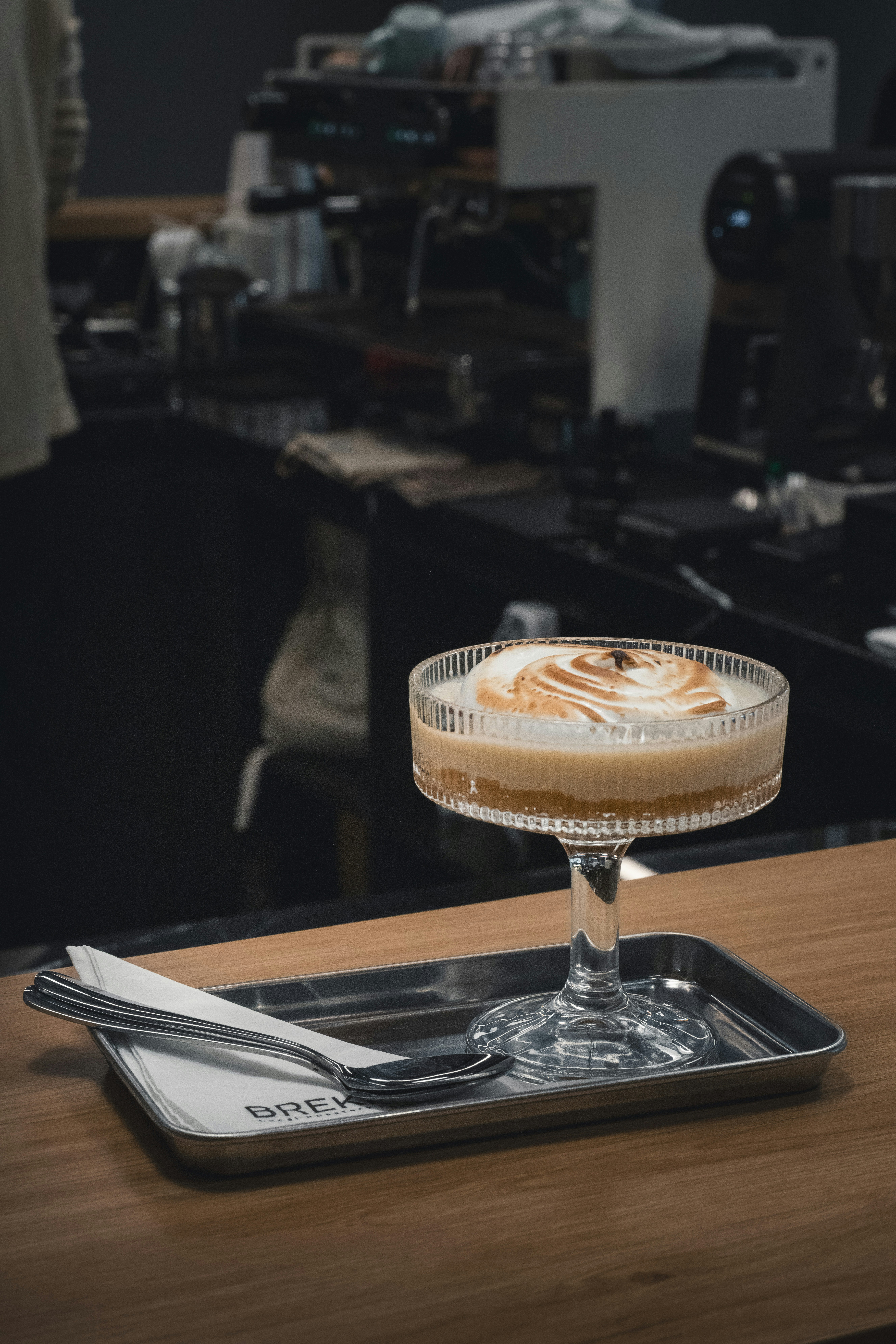 Cafe-topped Caramel: A Glass of Latte Art on a Bar Tray