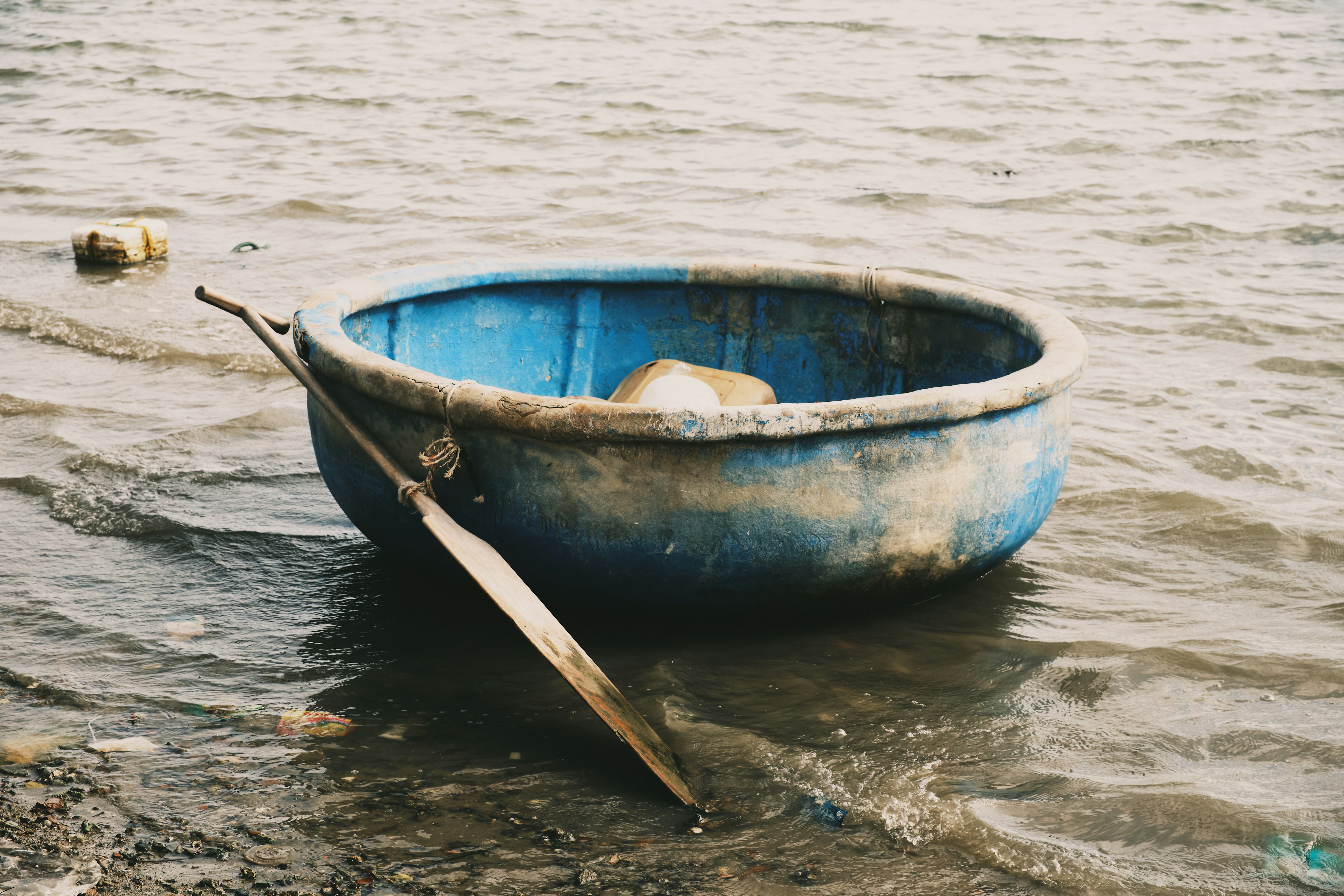 Blue Round Boat Resting in Tidal Mire
