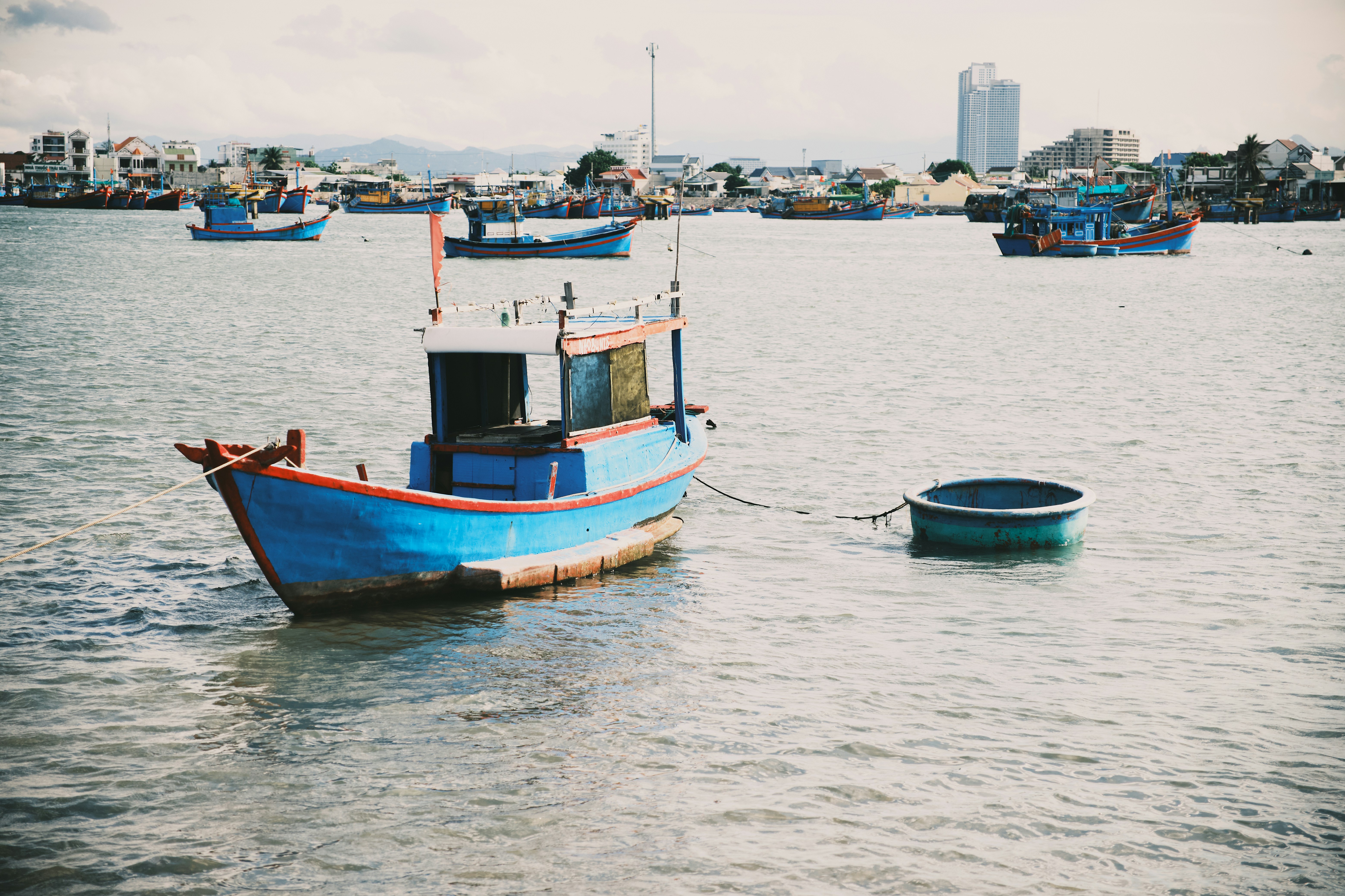 Blue Boat in Calm Harbor: A Quiet Morning by the Docks