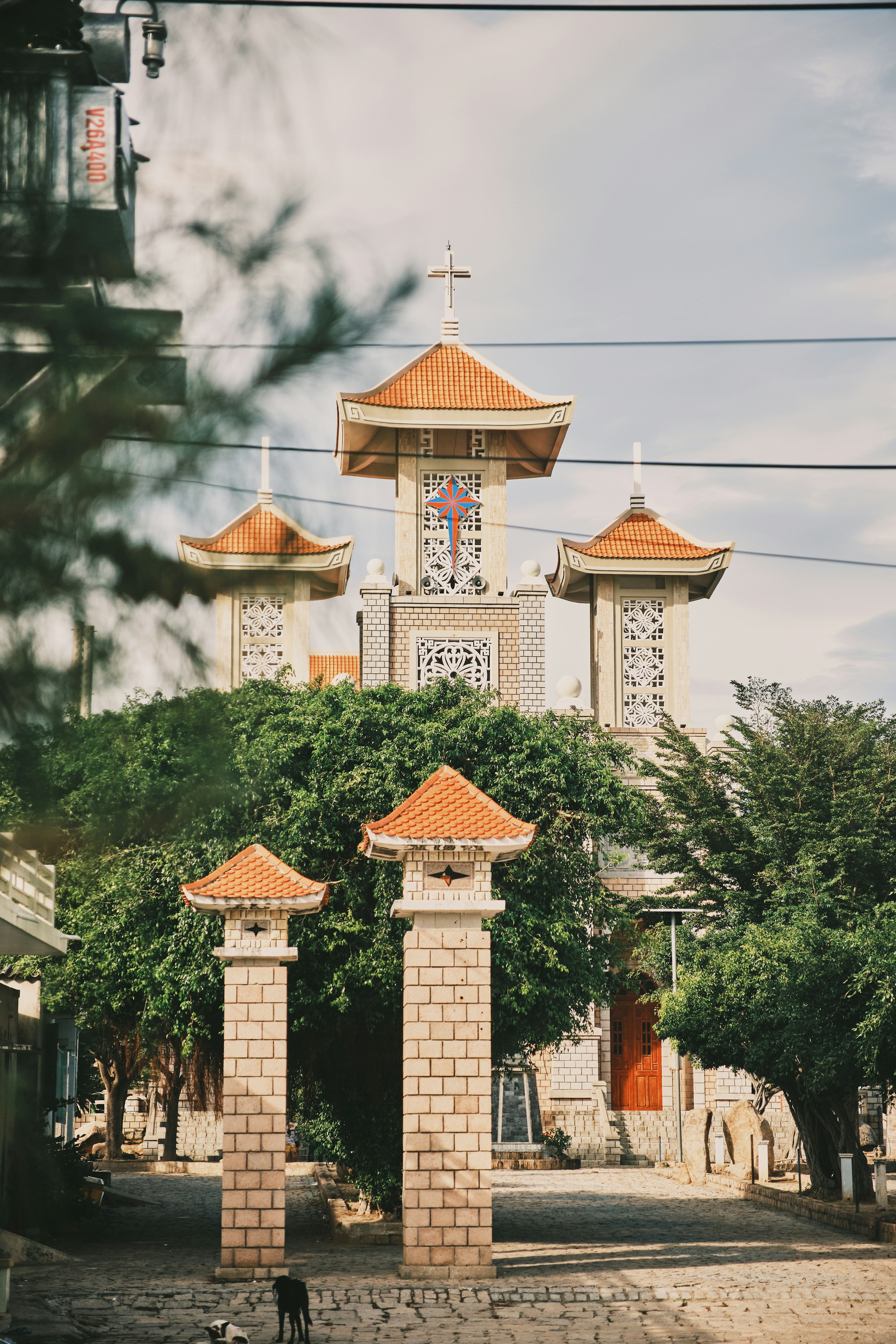 Temple Gateways and Red-Tiled Turrets Rising Above a Shadowed Courtyard
