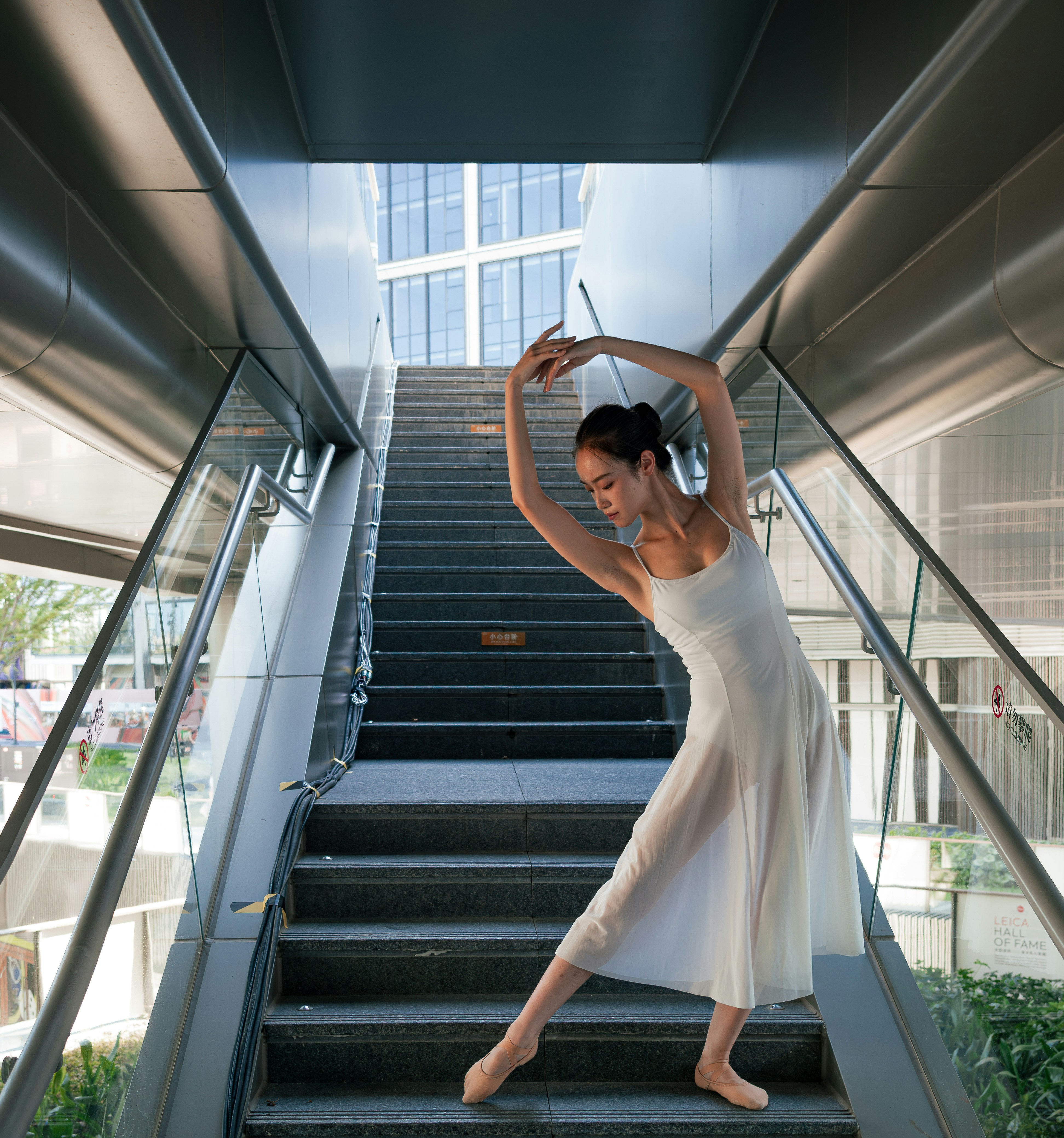 Graceful Arc: Ballet Pose on Neon Staircase