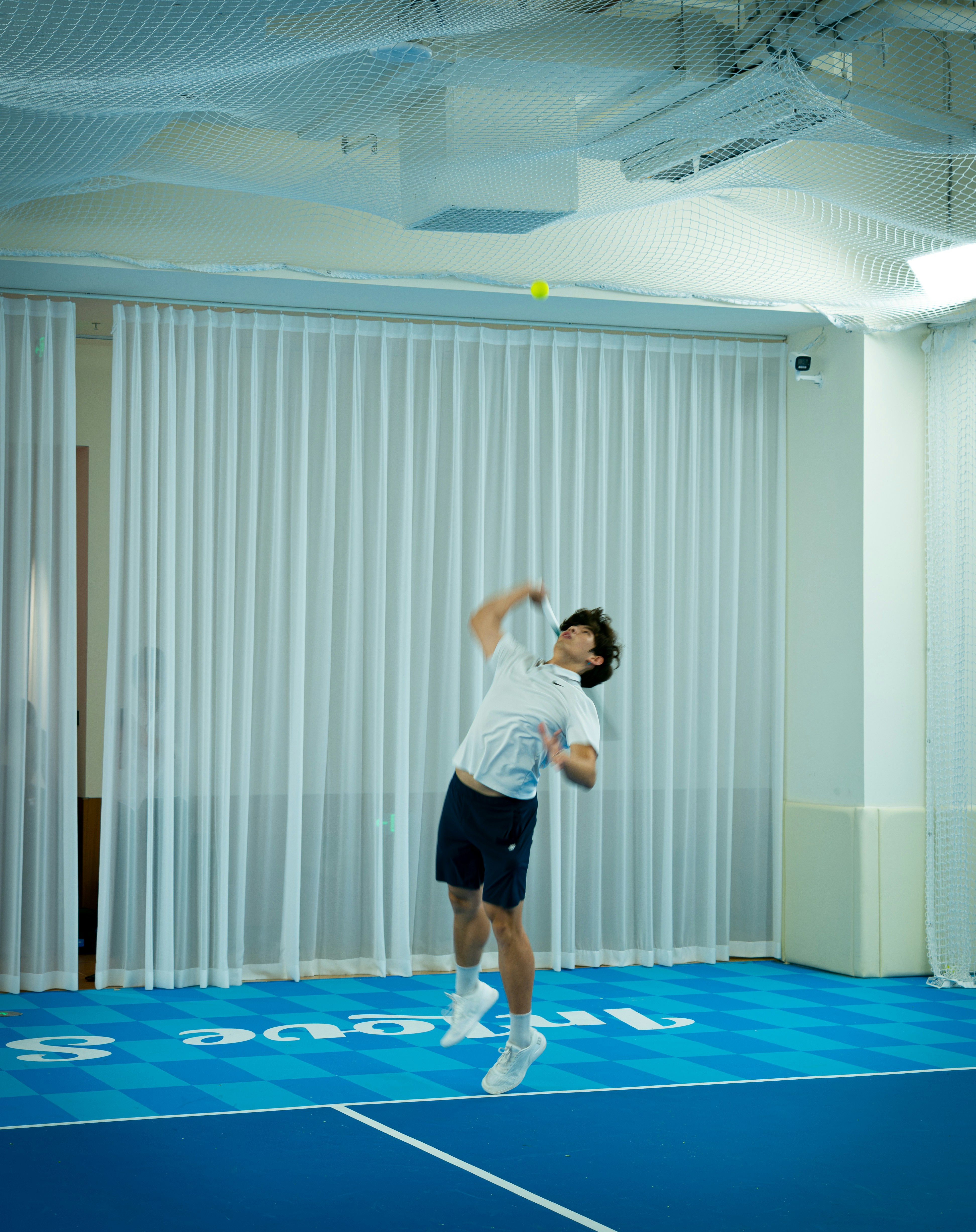 Midair Serve: A Tennis Rally Inside a Modern Indoor Court
