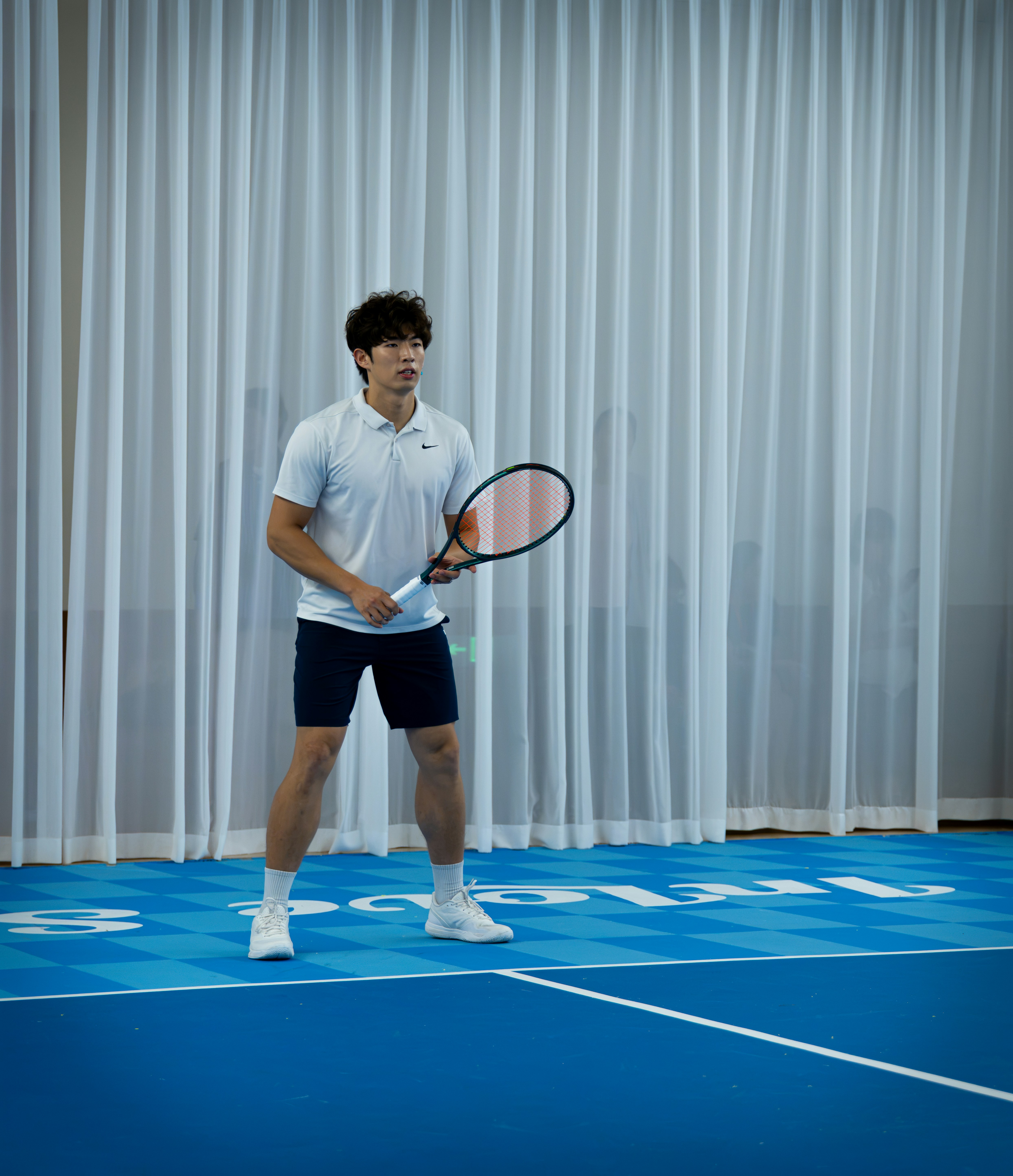 Midcourt Tennis Player Ready to Return a Serve