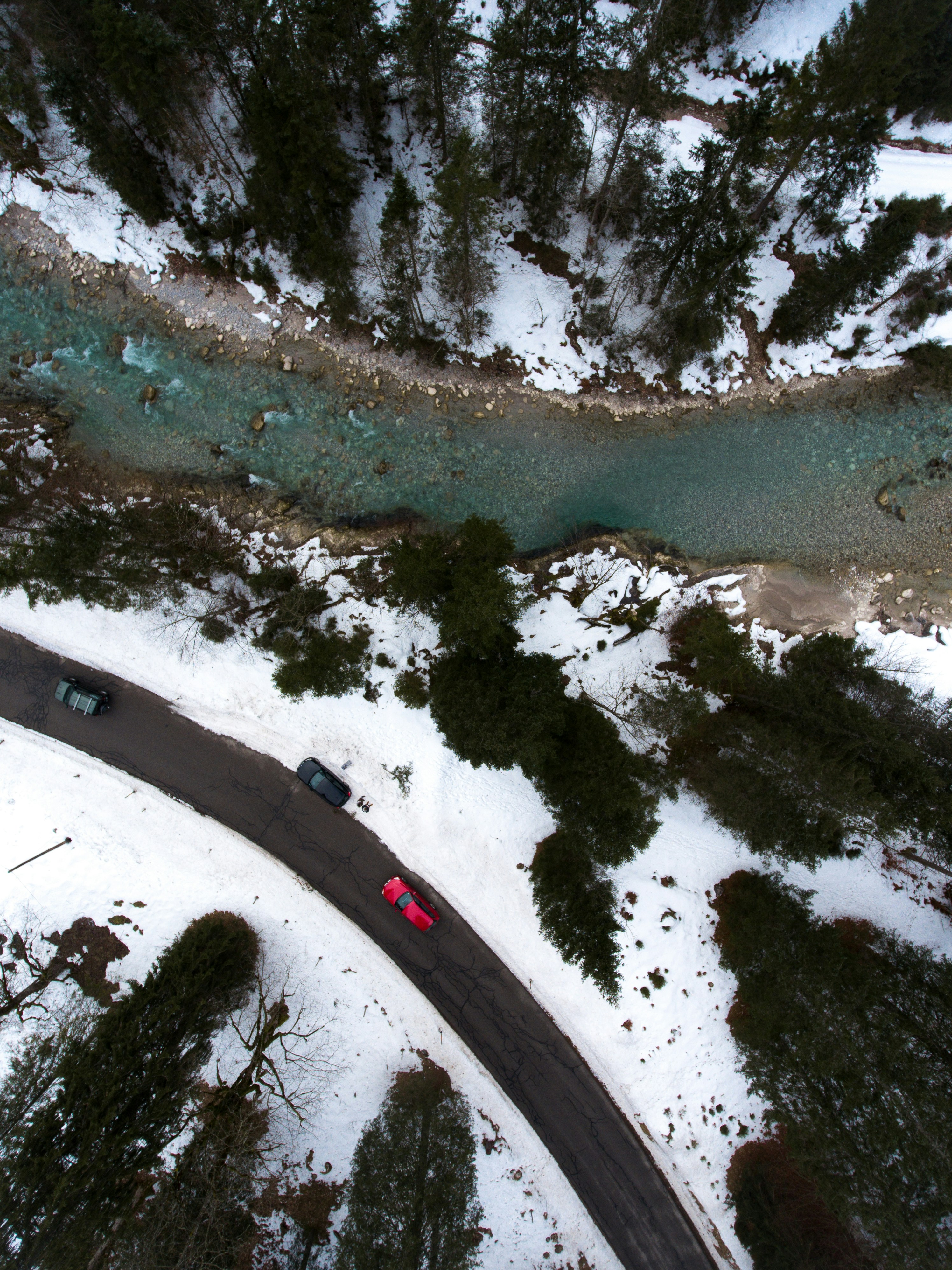 Snow-Curtained River Curve: Aerial Drive Through a Winter Gorge