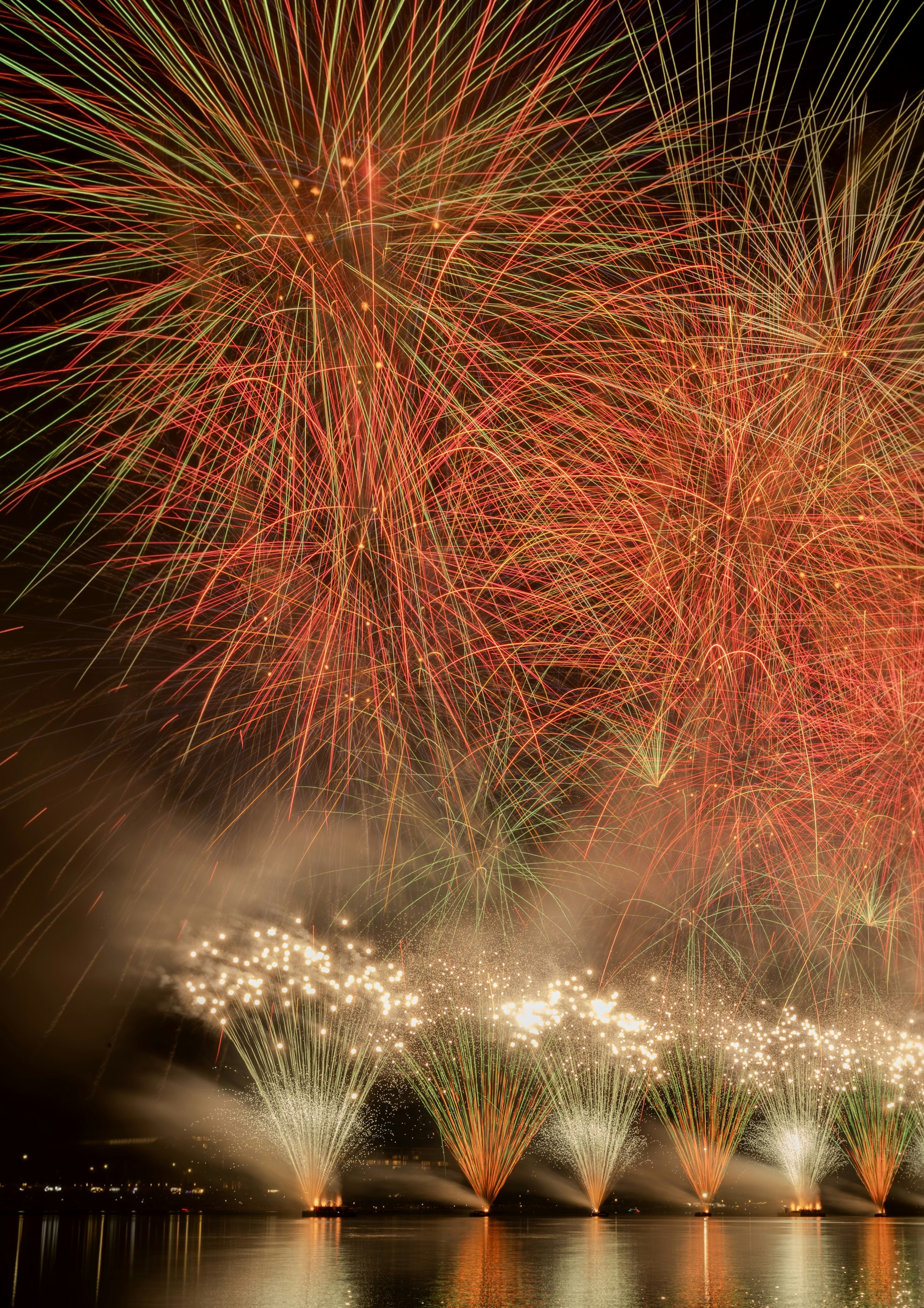 Firework Mirror: Night Sky Ablaze Over Quiet Waters